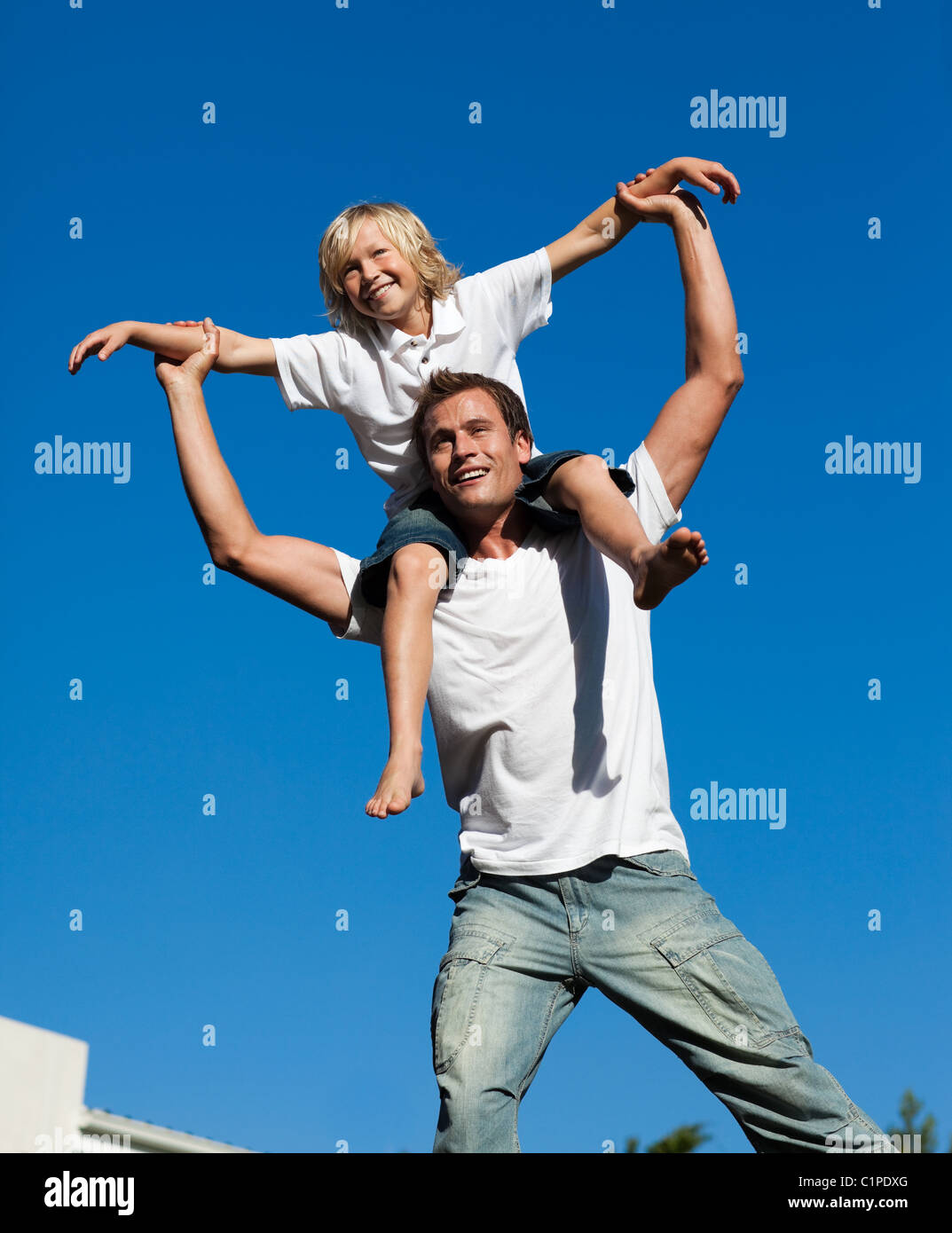 Young father with his son on his back outdoor Stock Photo - Alamy