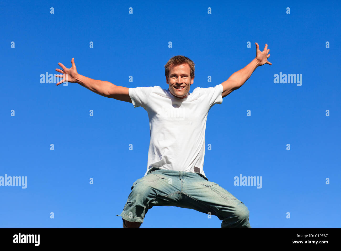 Portrait of a Young Man jumping in the air outdoor Stock Photo - Alamy