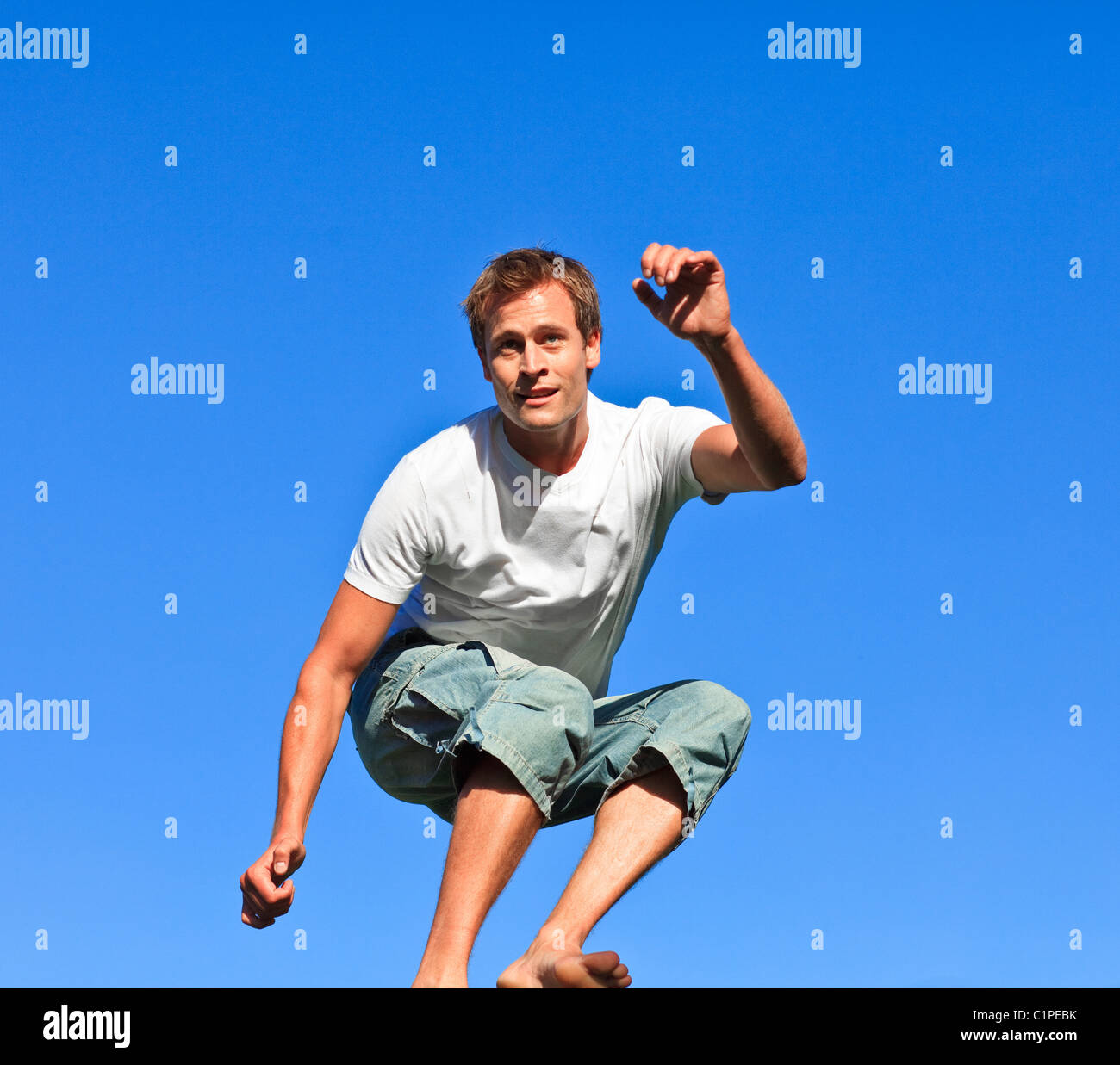Portrait of a handsome Man jumping in the air outdoor Stock Photo - Alamy