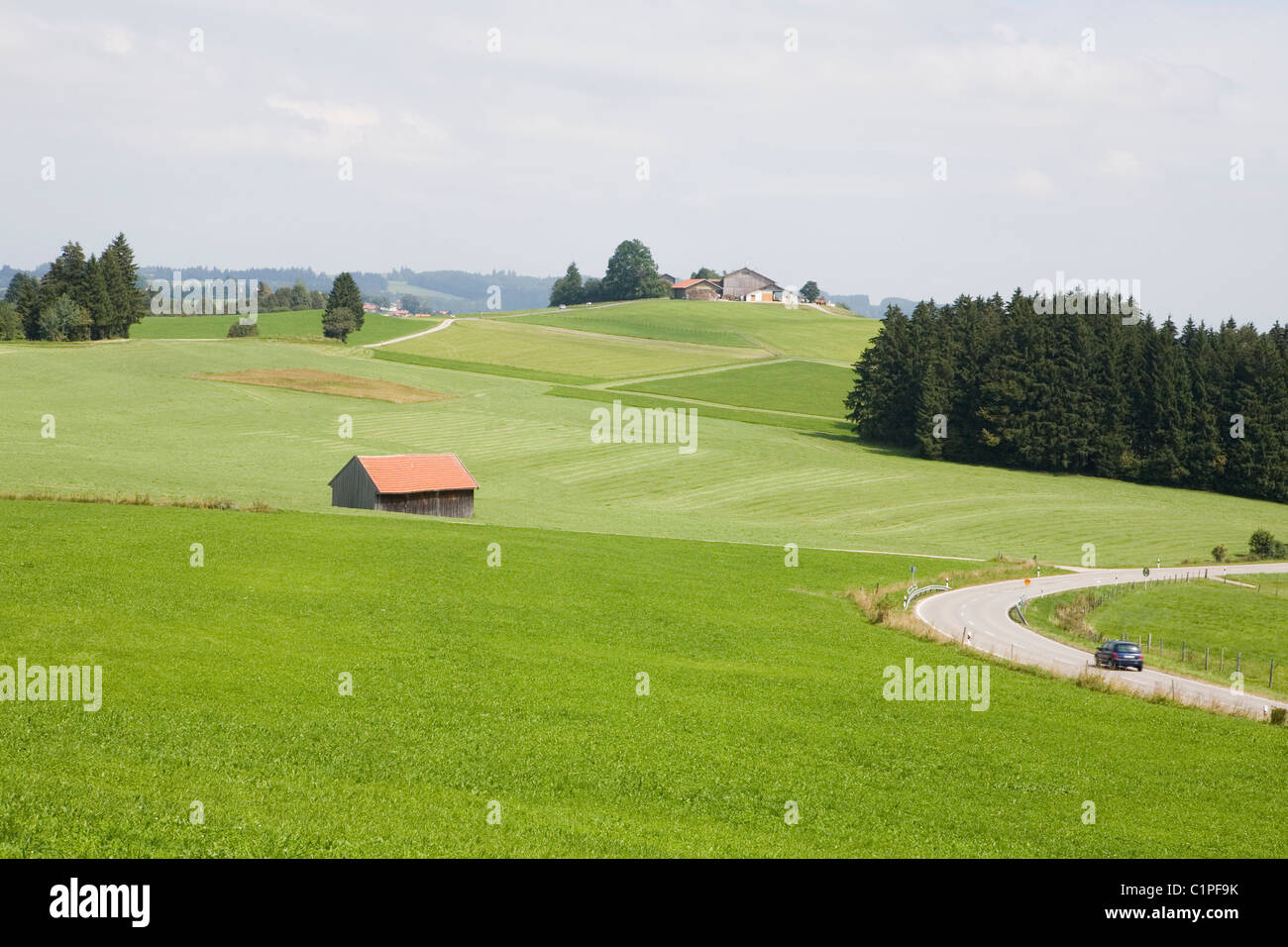 Car on road and barn in green countryside hi-res stock photography and ...