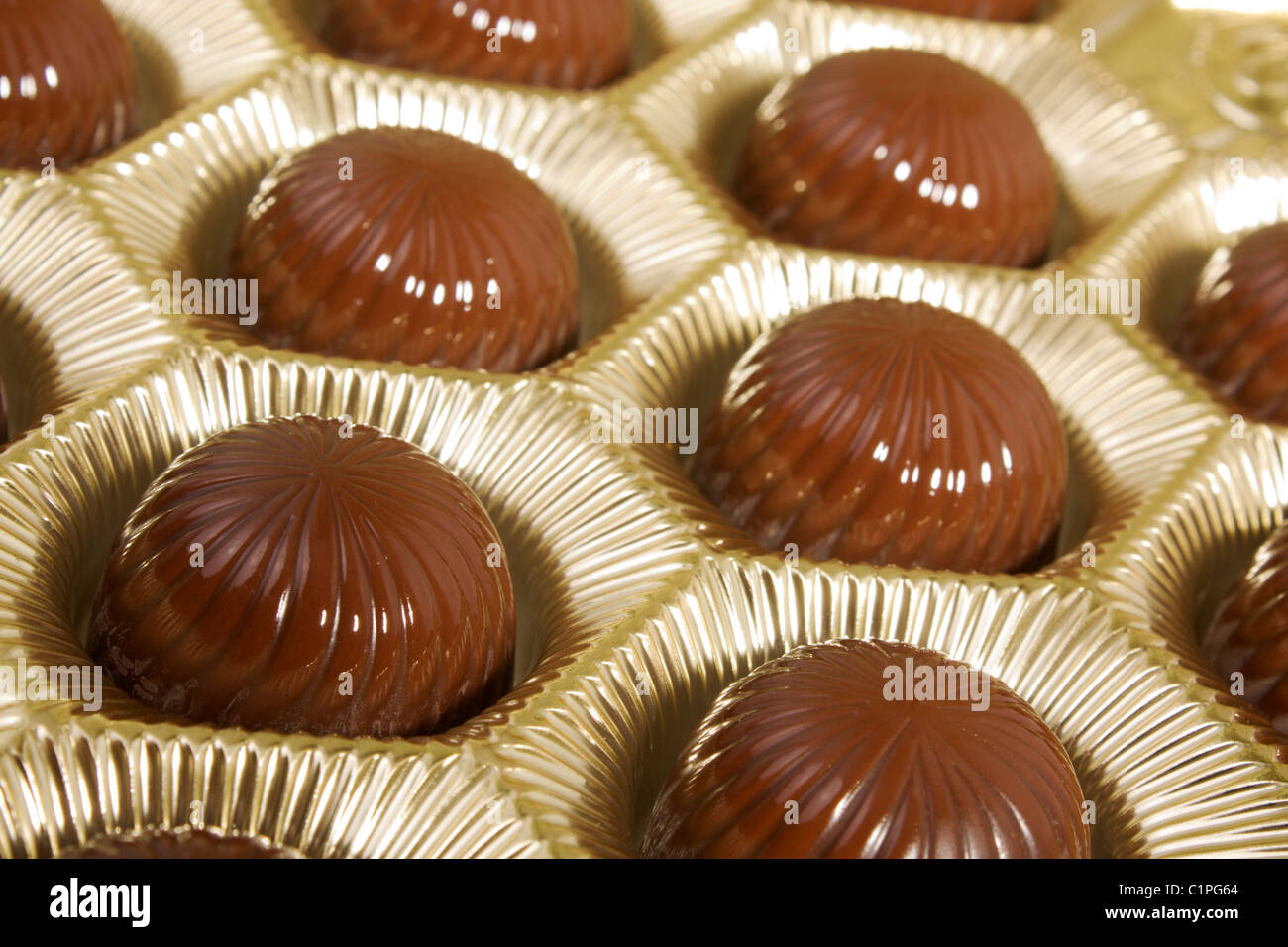 Box of chocolates inside. Dark chocolate in gold foil Stock Photo - Alamy