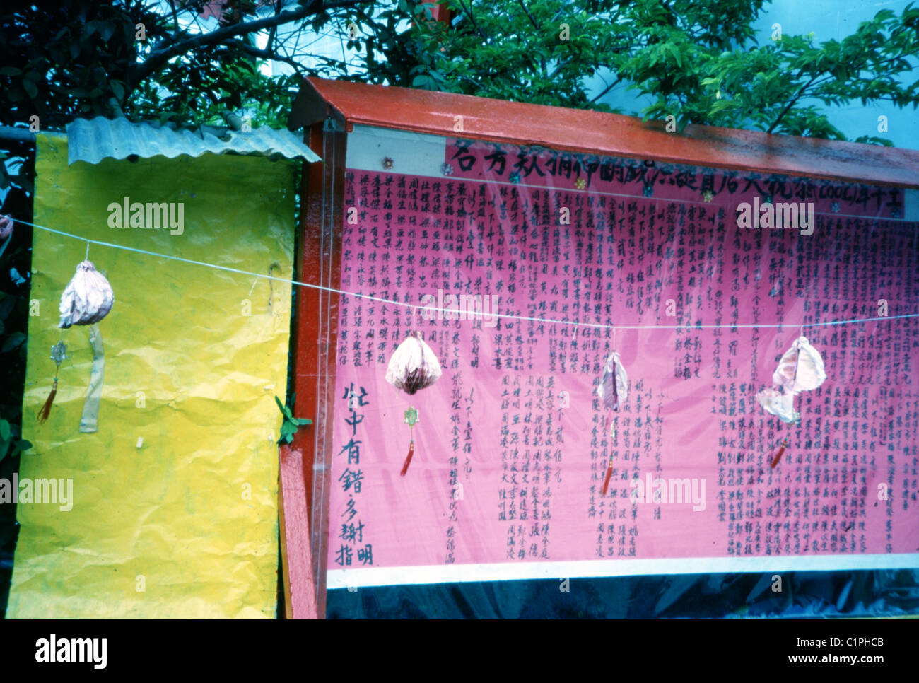 A public noticeboard on Lamma Island, Hong Kong, in pink with Chinese ...