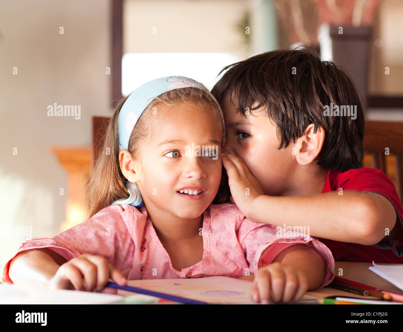 Children telling secrets hi-res stock photography and images - Alamy
