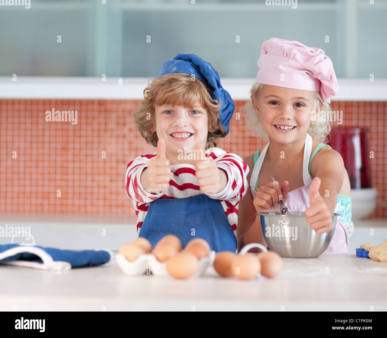 Cheerful siblings with thumbs up Stock Photo - Alamy