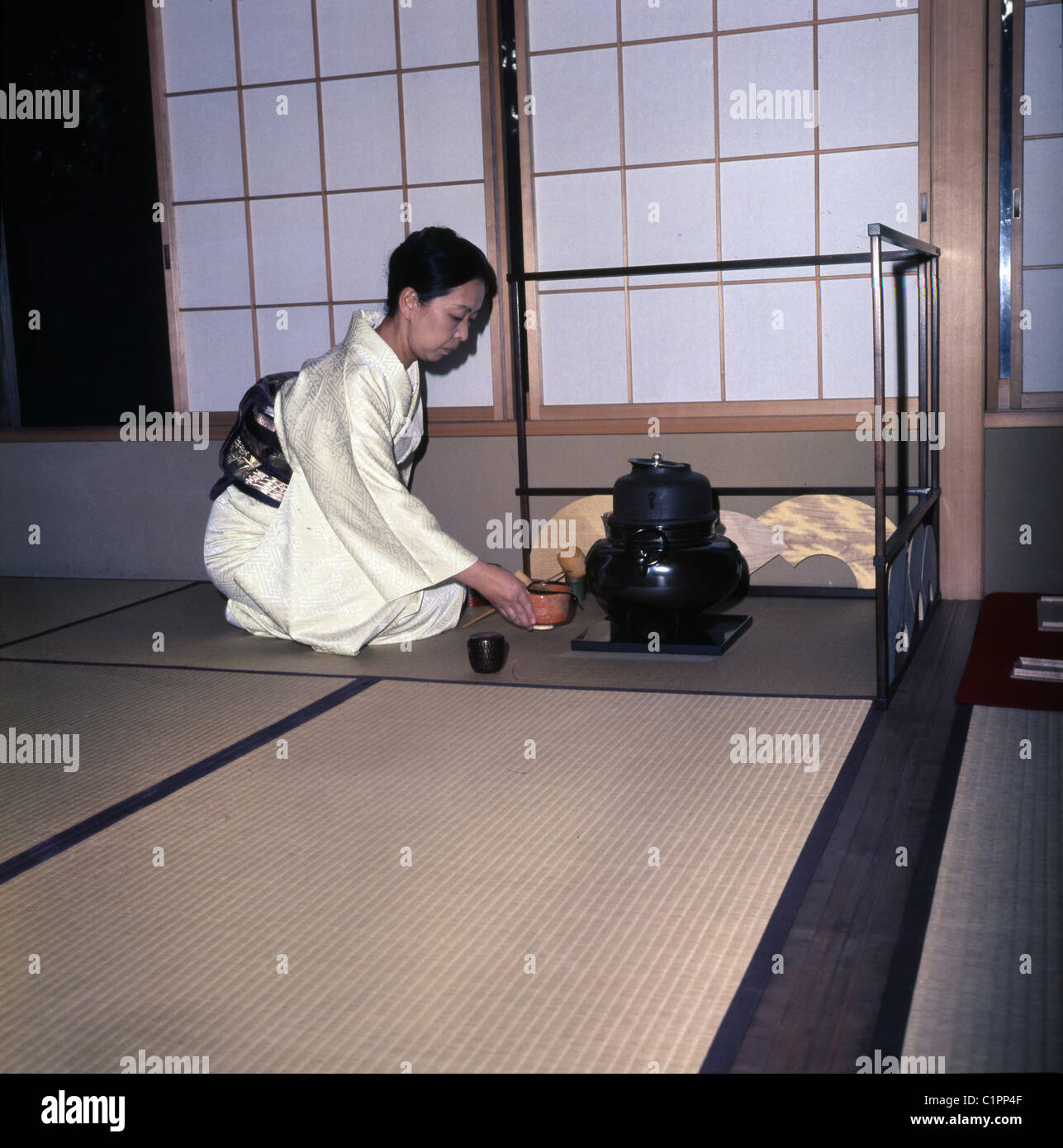Picture from the 1970s of Japanese lady kneeling-down on floor to ...