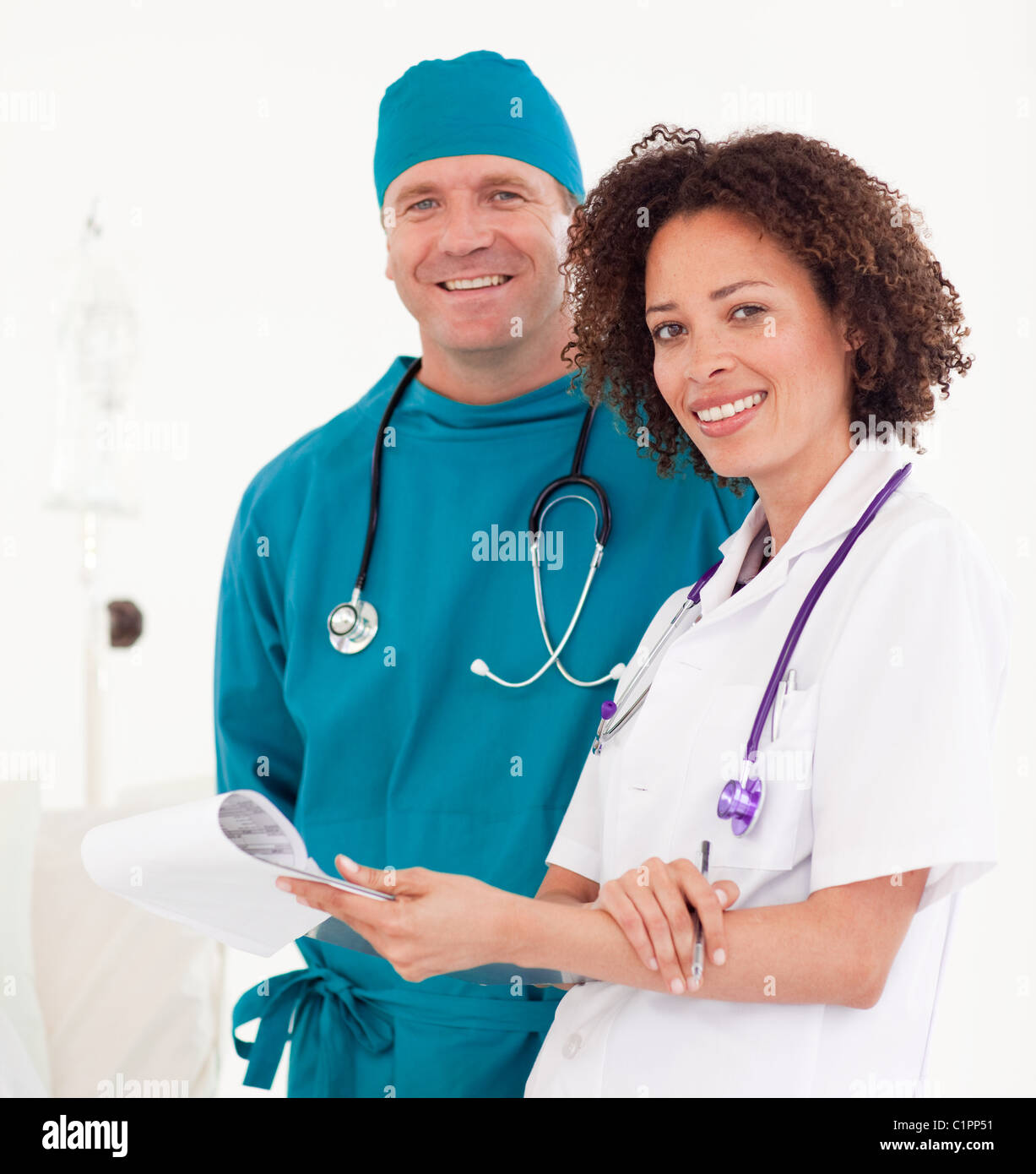 Pretty surgeon in blue scrubs presenting on white background Stock ...