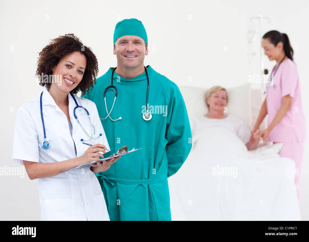 Medical team attending female patient hi-res stock photography and ...