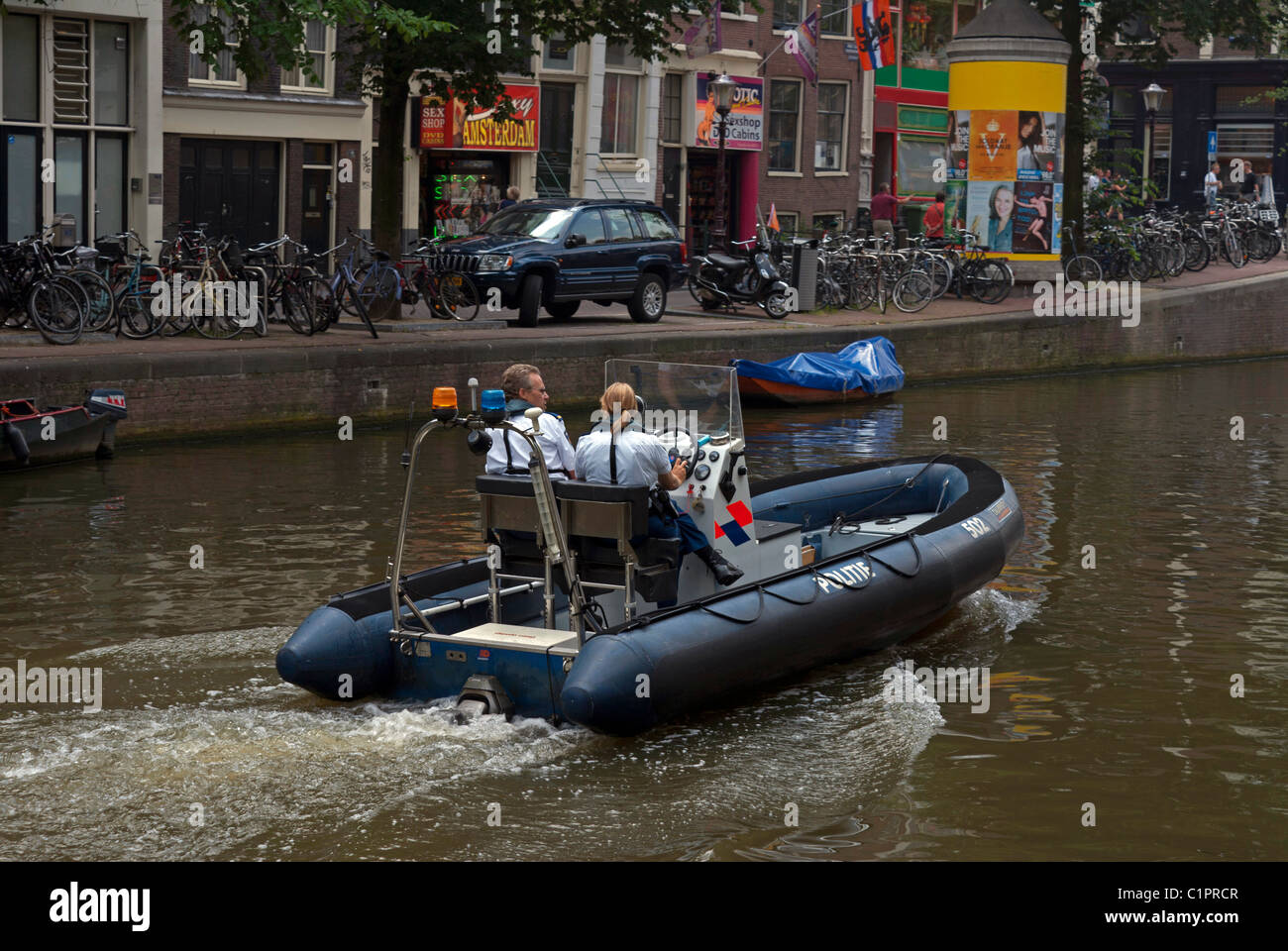 A police boat on patrol on a canal in Amsterdam Stock Photo - Alamy