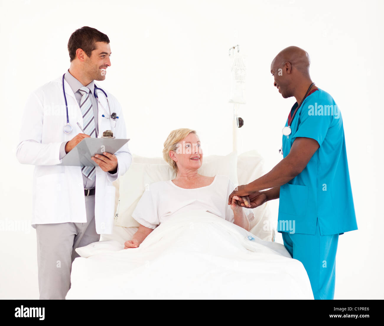 Team of doctors with a patient Stock Photo - Alamy
