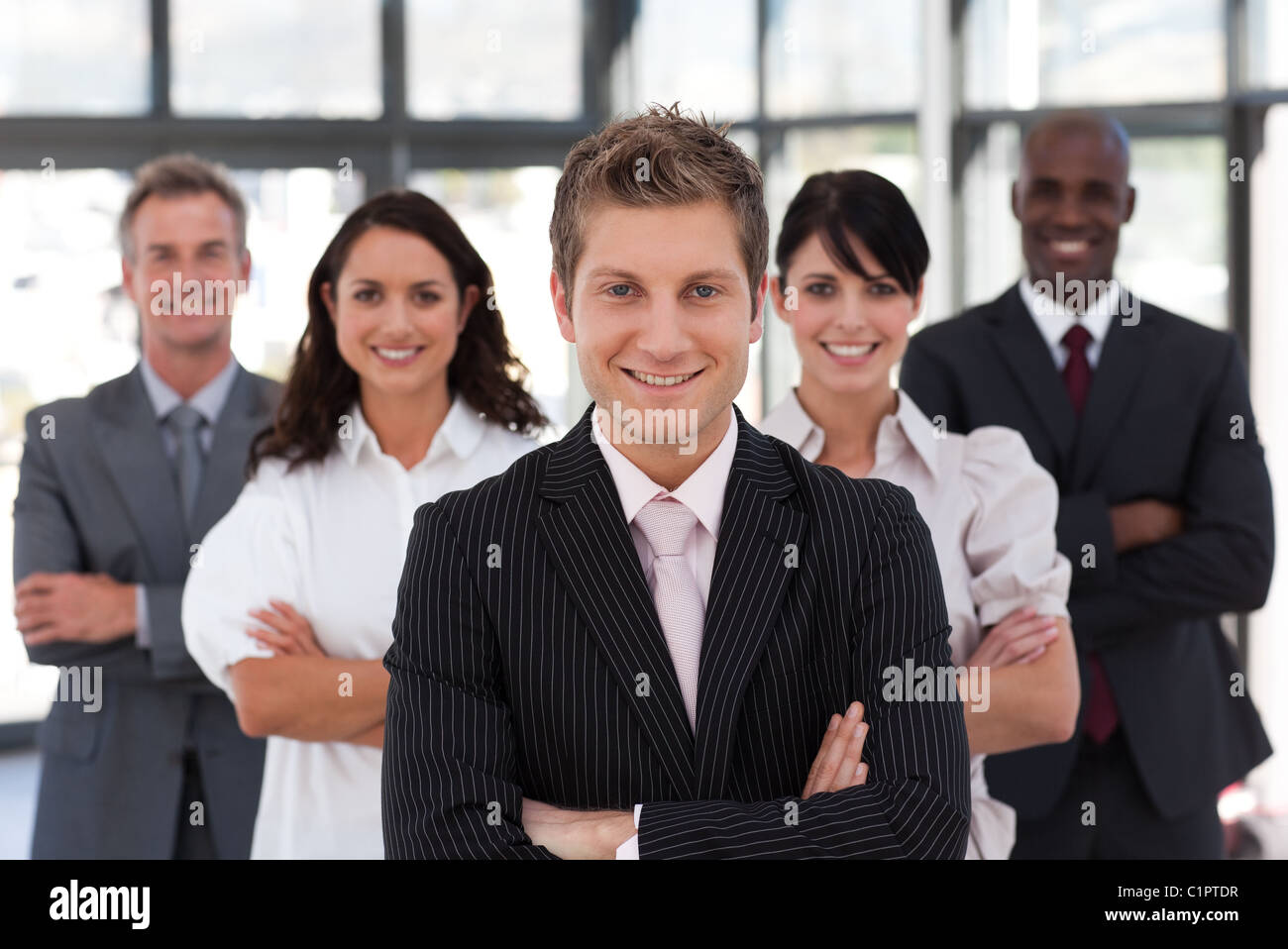 Cute business team looking at the camera Stock Photo - Alamy