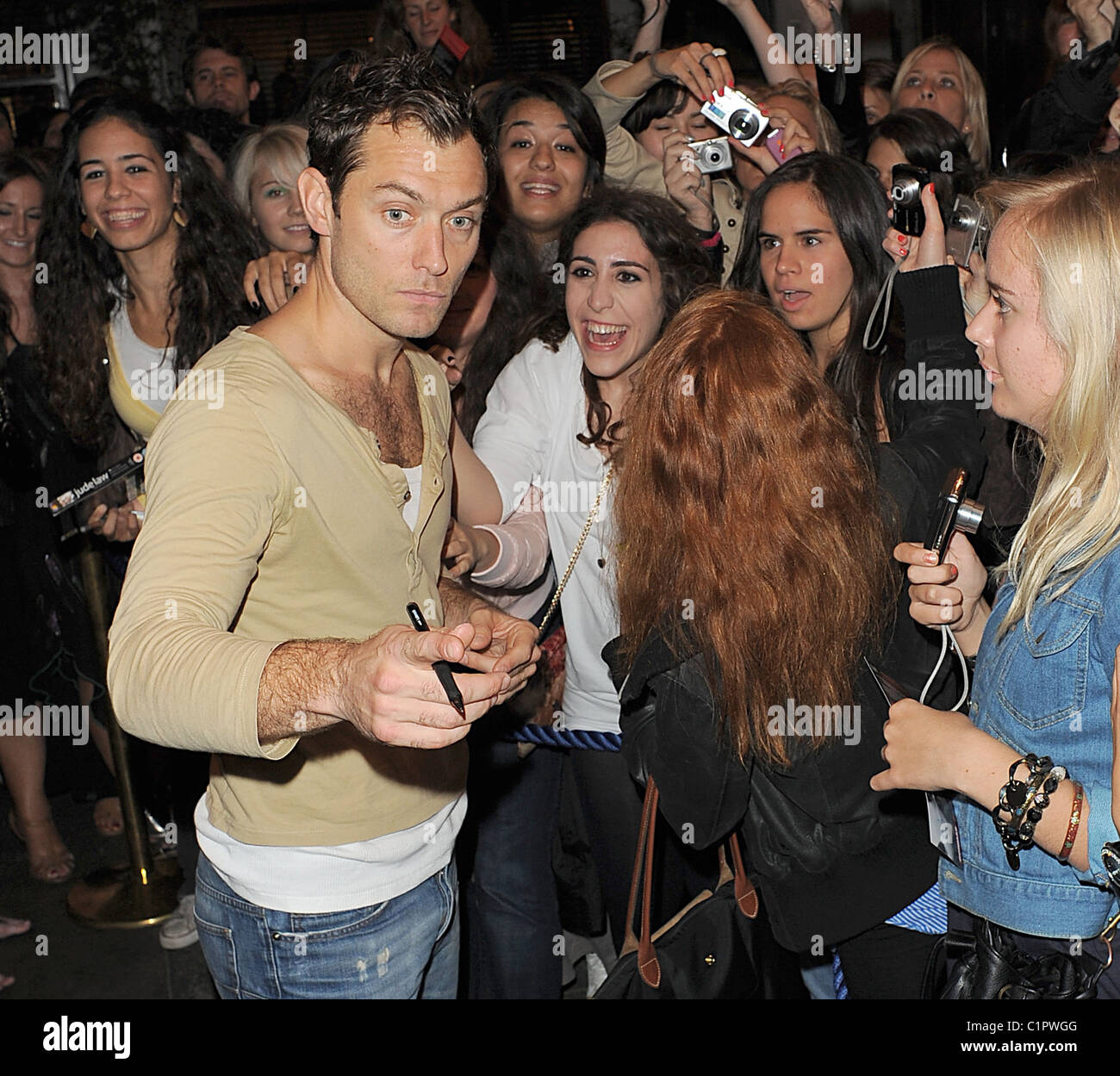 Jude Law is swamped by a huge number of fans wanting his picture and ...