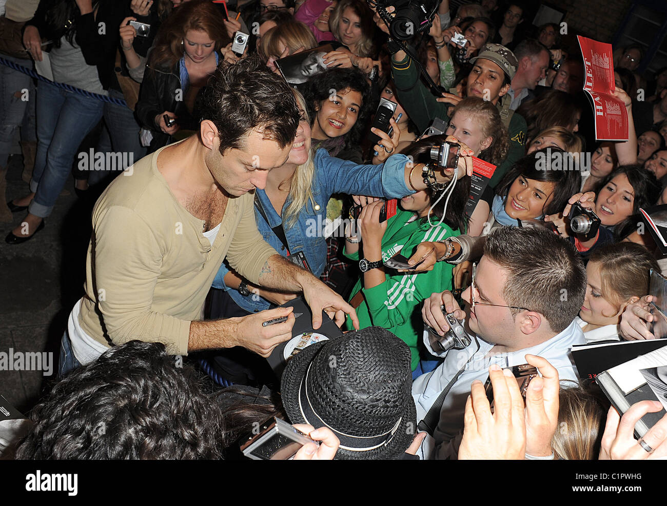 Jude Law is swamped by a huge number of fans wanting his picture and ...