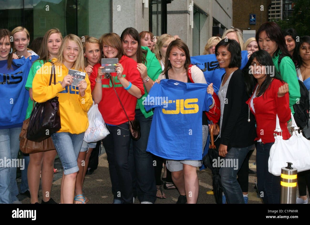 JLS fans wait outside the ITV studios for the band to leave after their ...