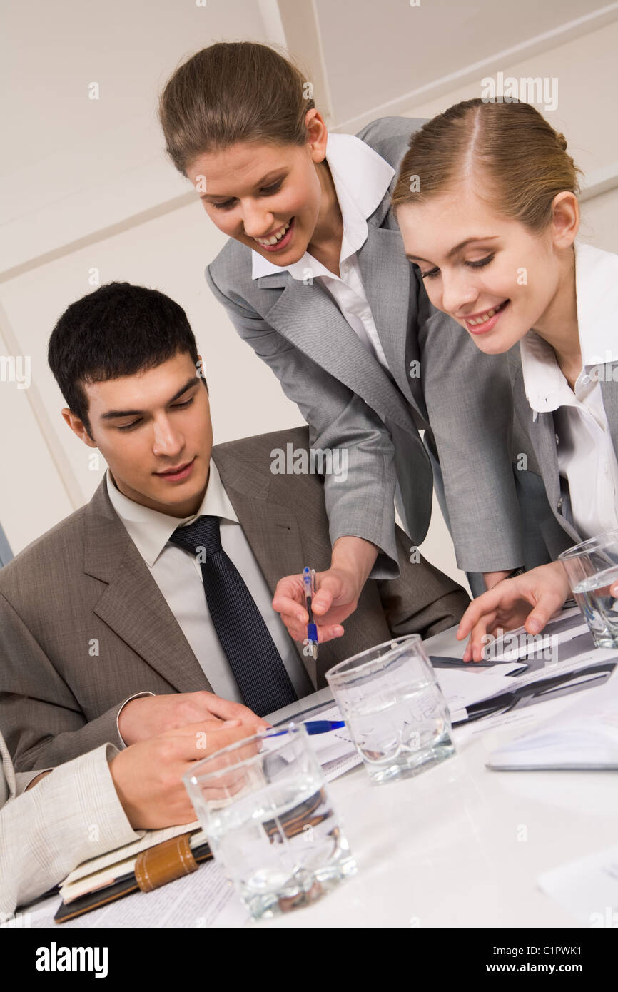 Portrait of busy people talking about new project and planning their ...