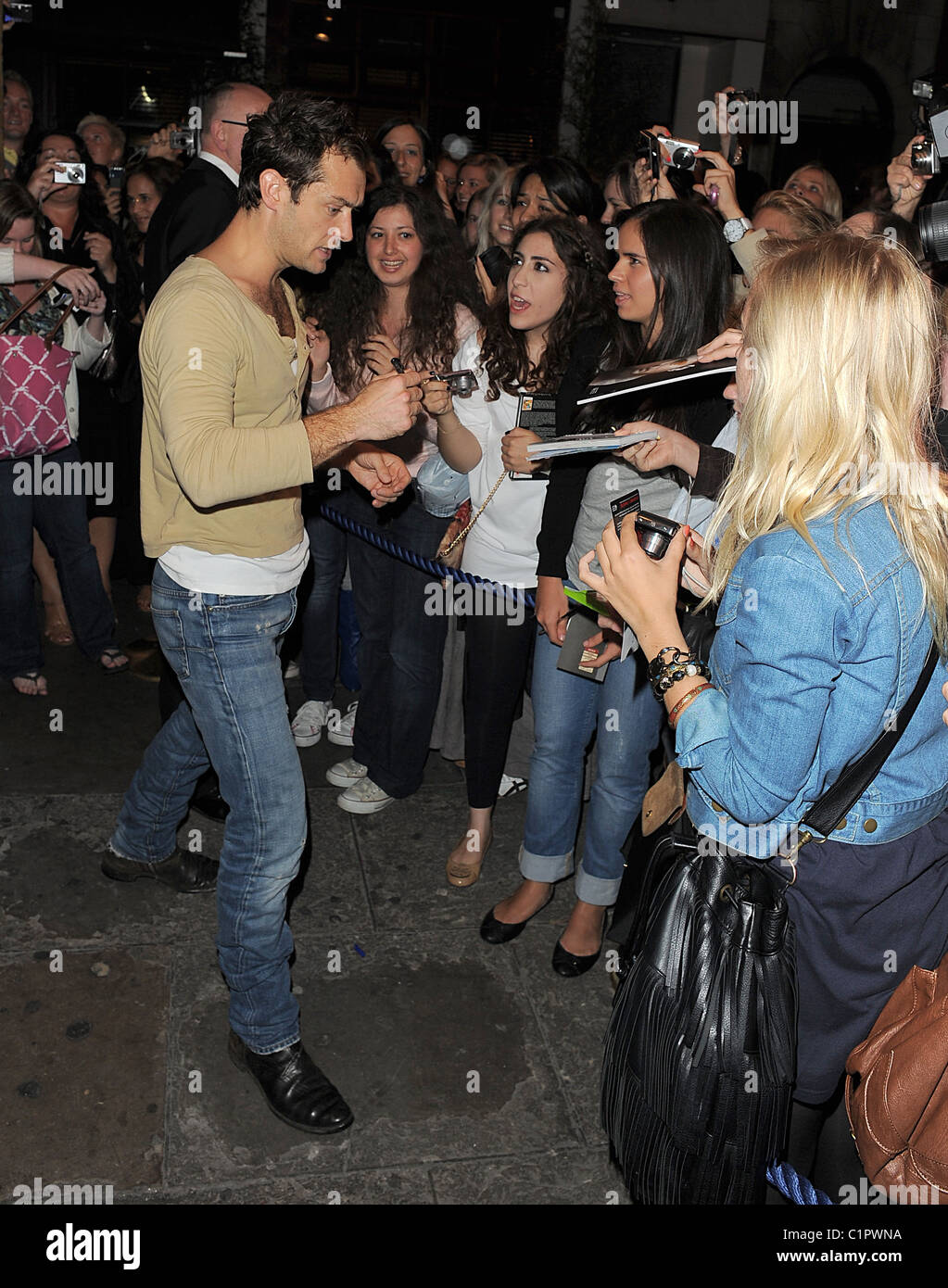 Jude Law is swamped by a huge number of fans wanting his picture and ...