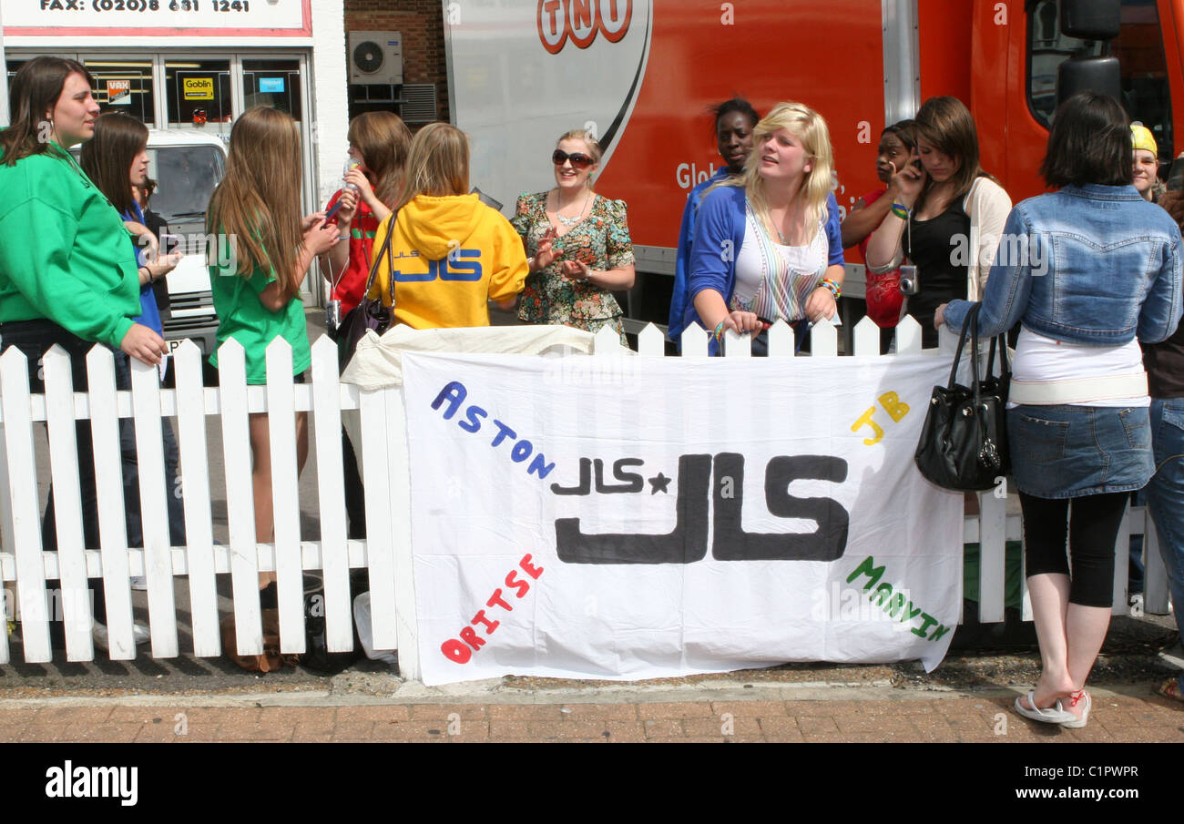 Fans wait eagerly outside an HMV store in Croydon where boyband JLS ...