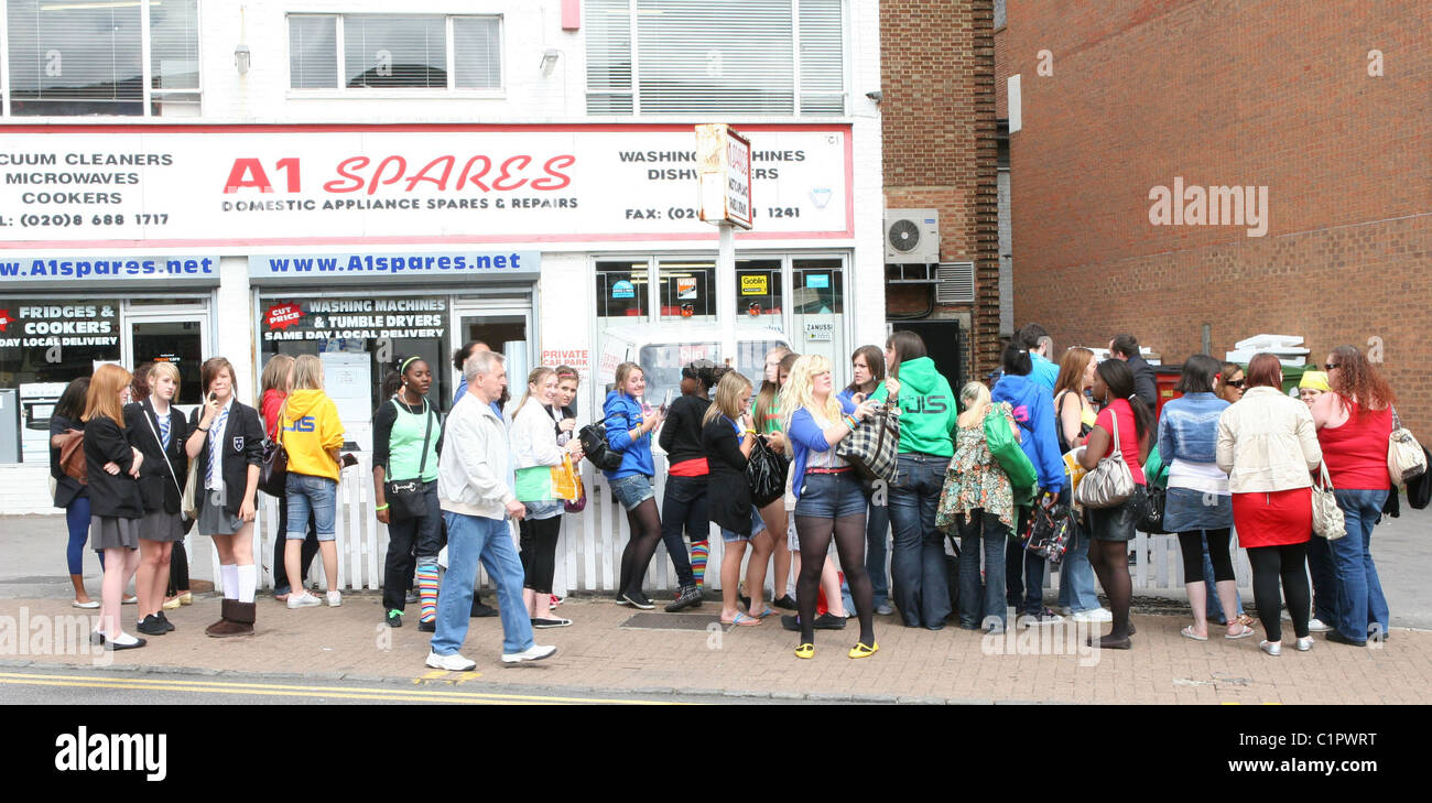 Fans wait eagerly outside an HMV store in Croydon where boyband JLS ...