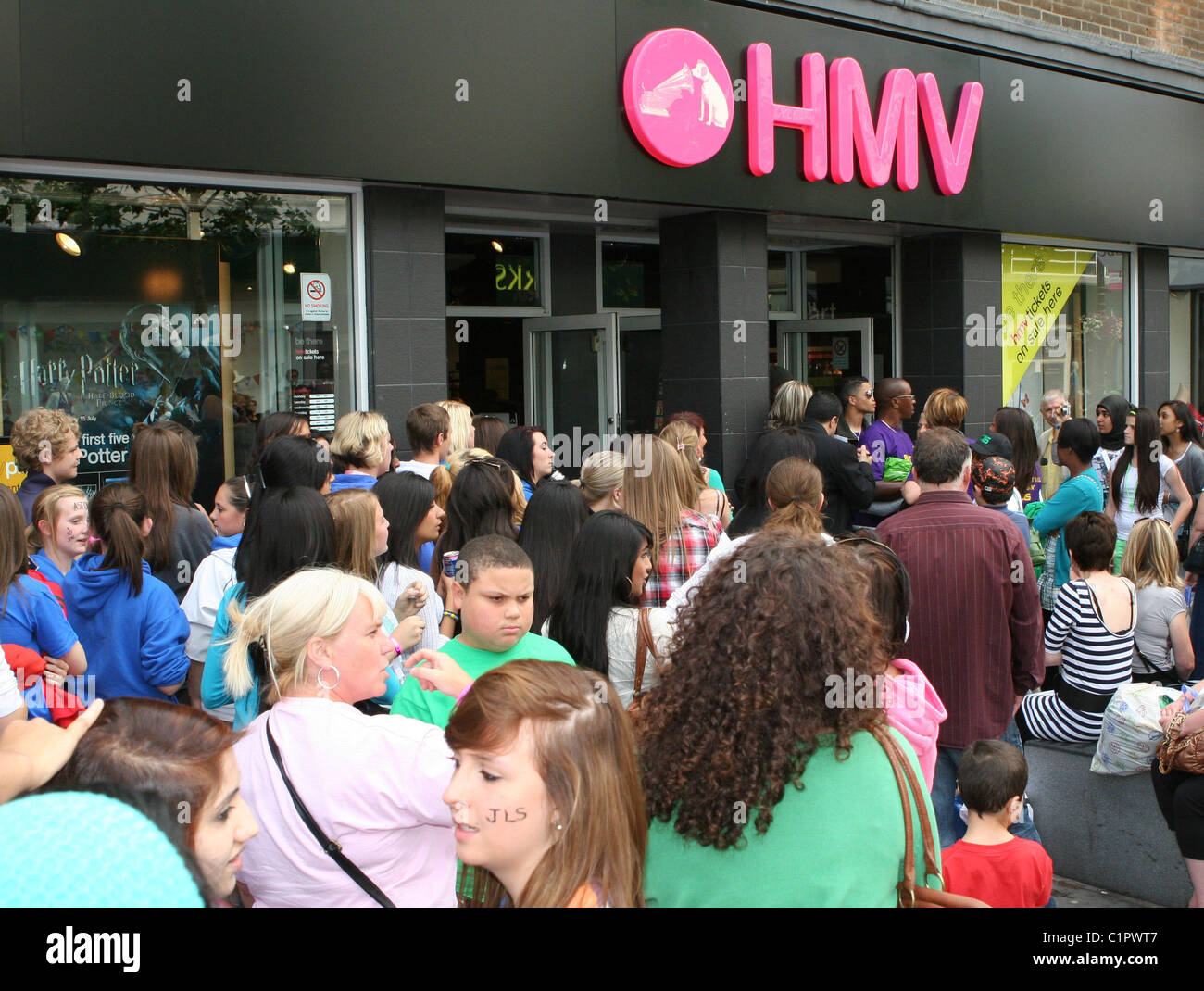 Fans wait eagerly outside an HMV store in Croydon where boyband JLS ...