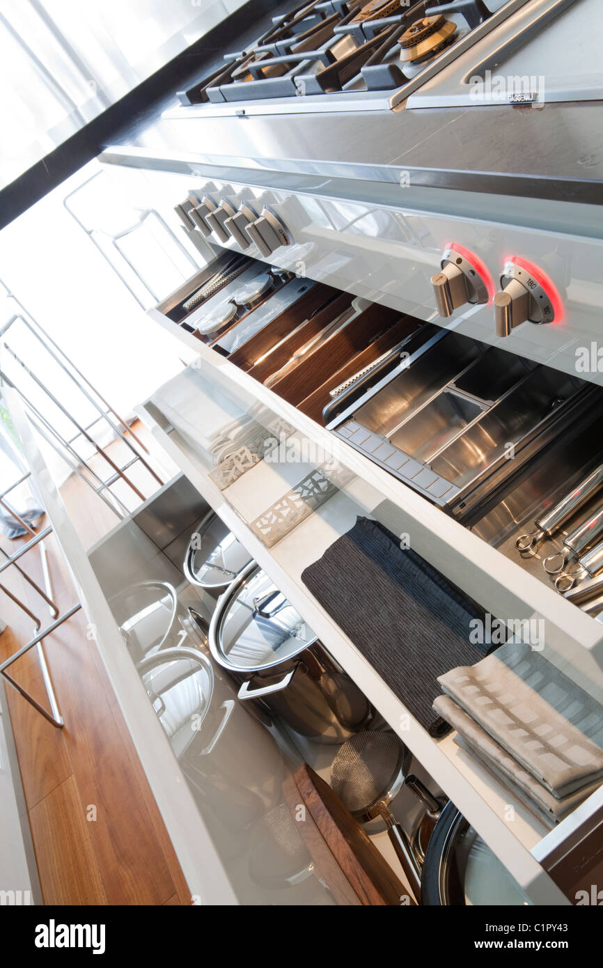 Modern equipped kitchen with practicable drawers under stove board ...
