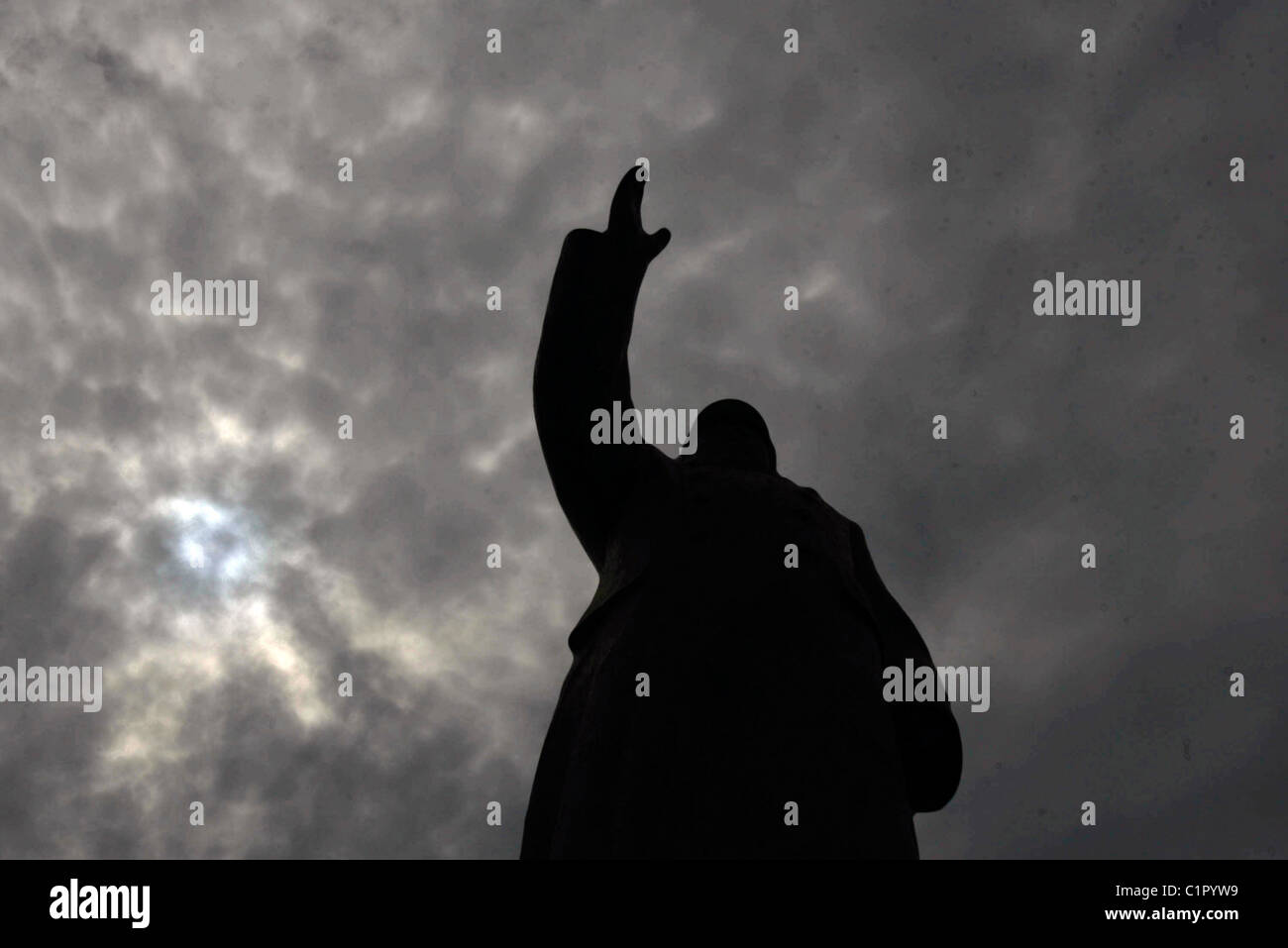 A solar eclipse is seen in the sky above Chairman Mao's statue in Wuhan ...