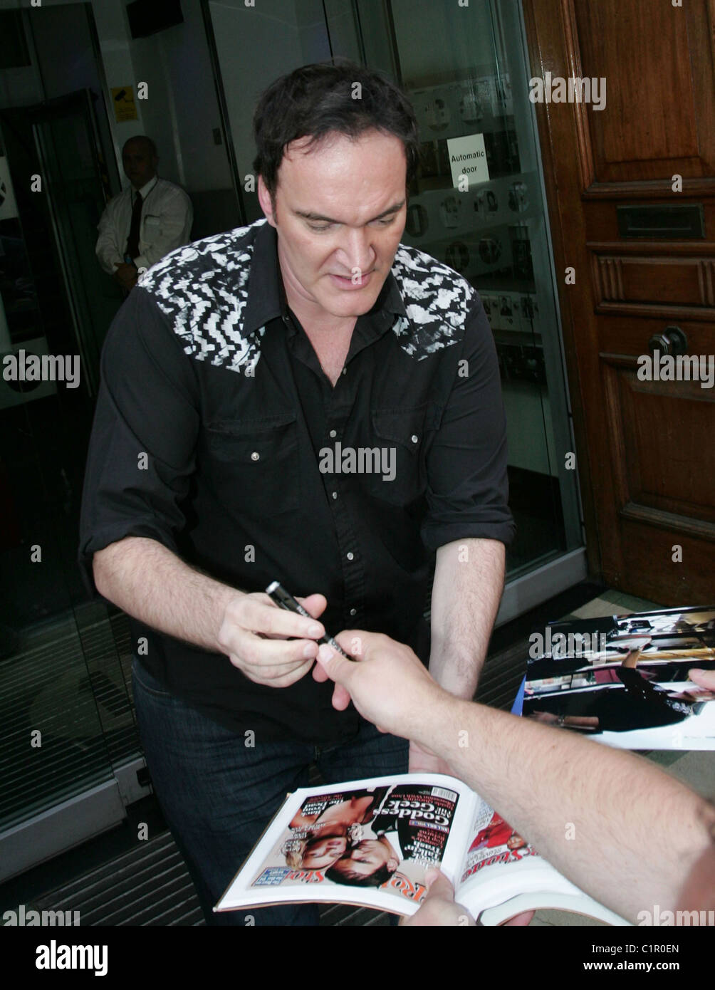 Quentin Tarantino signs autographs after leaving the Radio One studios ...