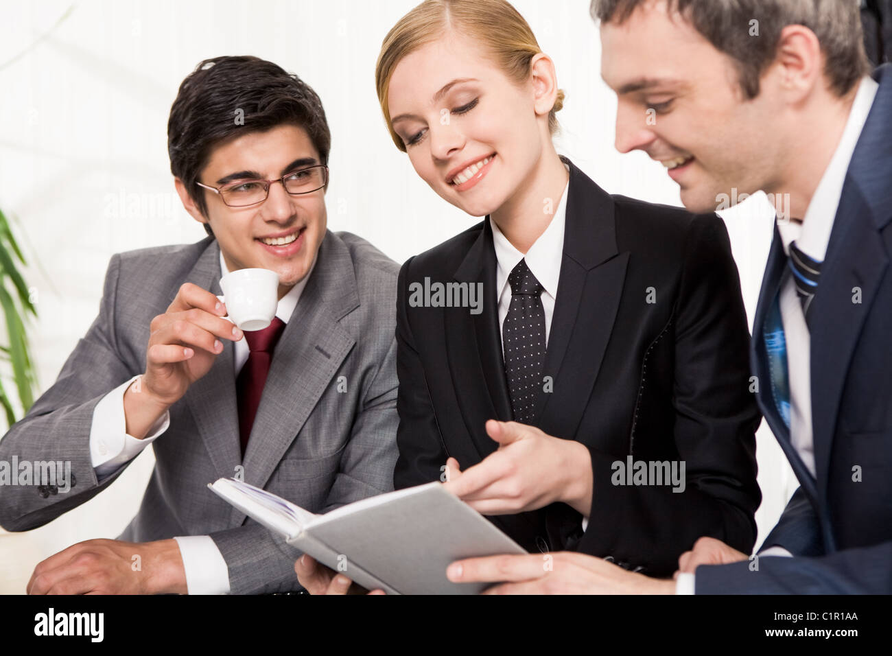 Portrait of busy people discussing new project or working plan Stock ...