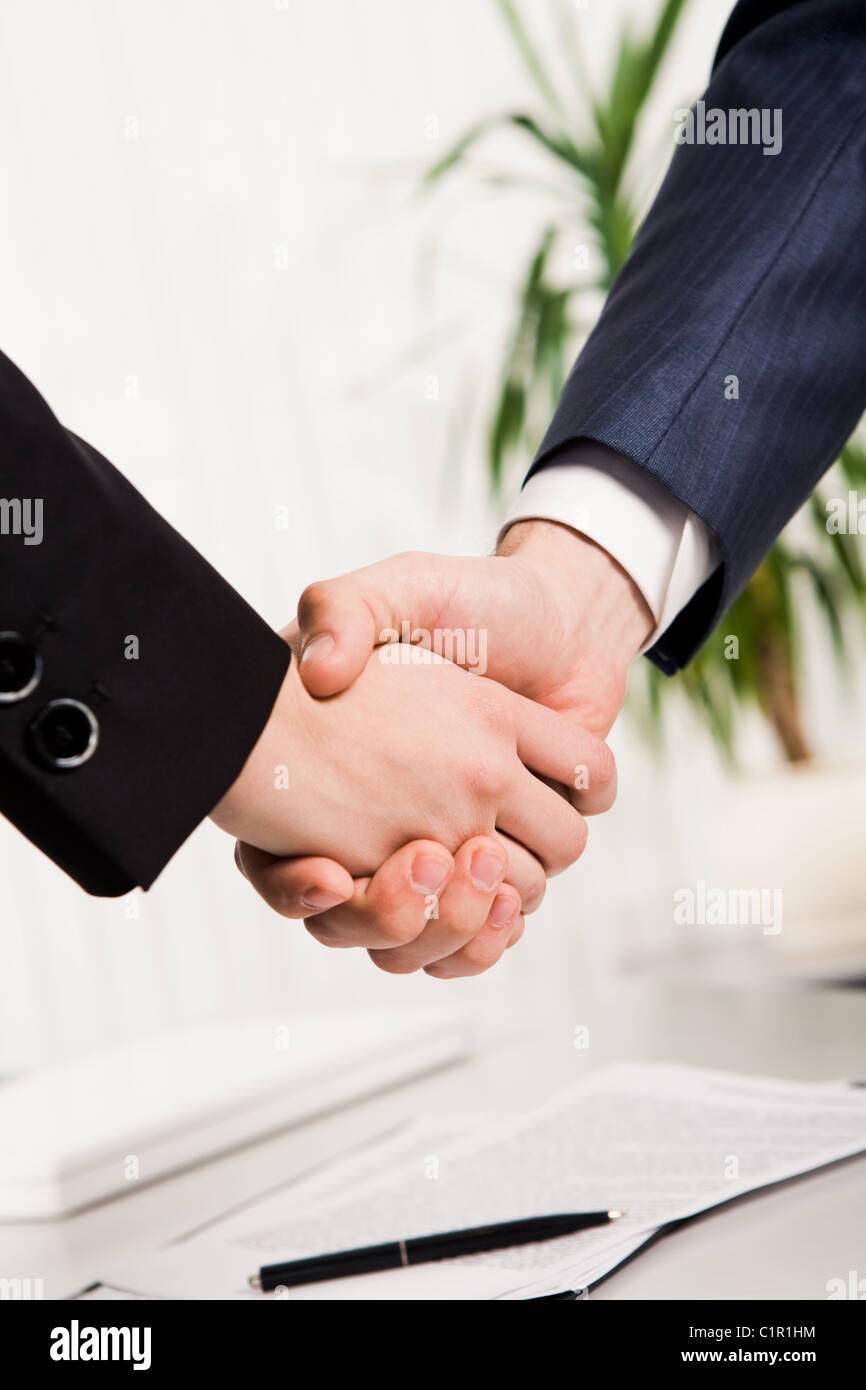 Photo of handshake of business partners after striking deal on ...