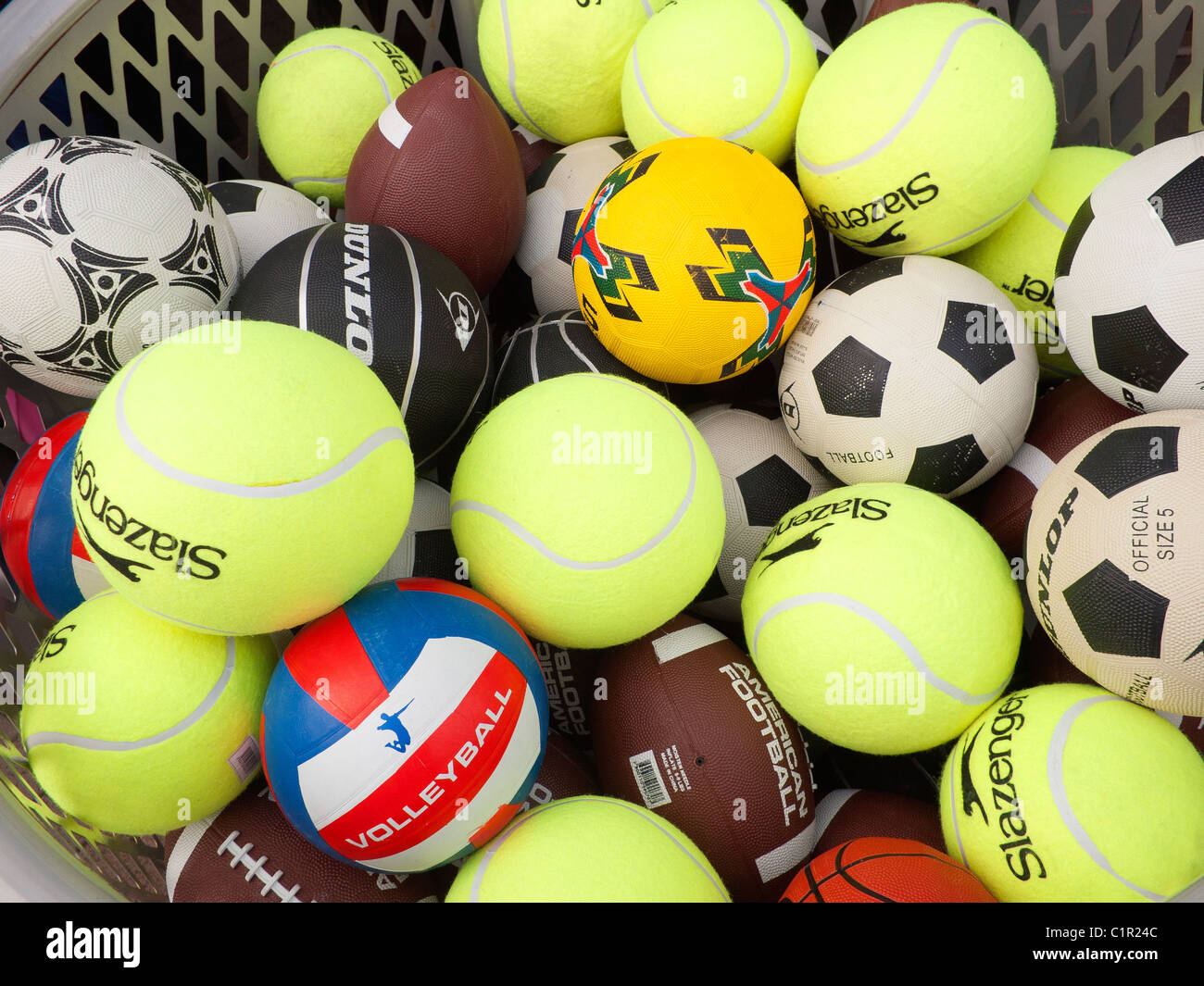 Cheap multi-coloured soccer sized balls for sale Stock Photo - Alamy