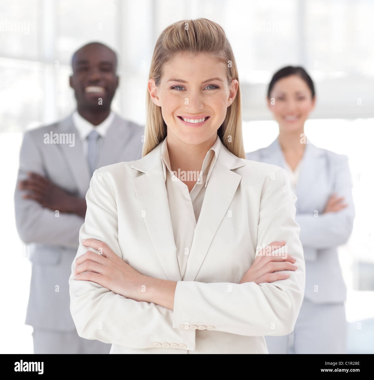 Smiling female manager with her team Stock Photo - Alamy