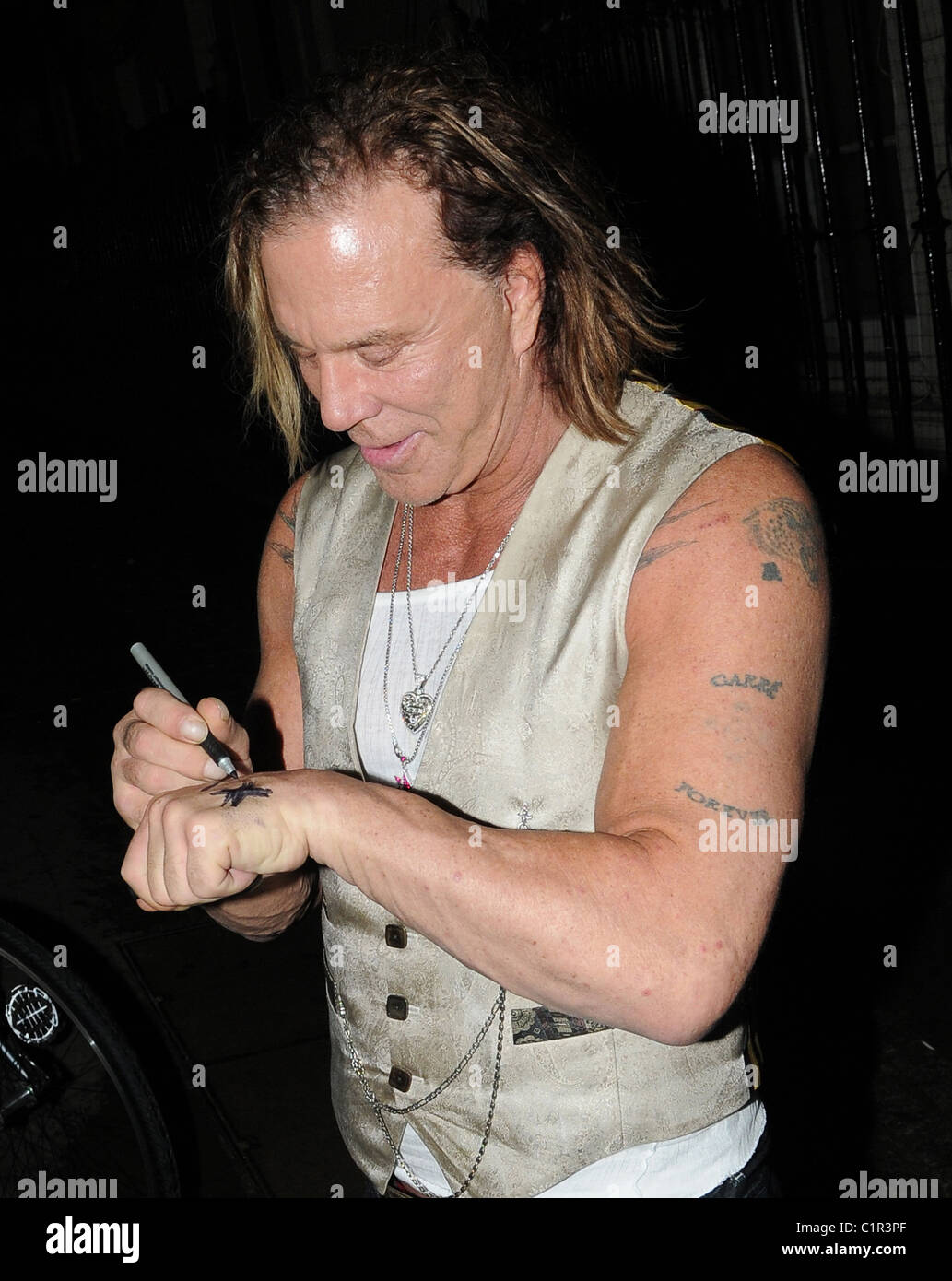 Mickey Rourke marks three crosses on his hand outside the Wellington ...