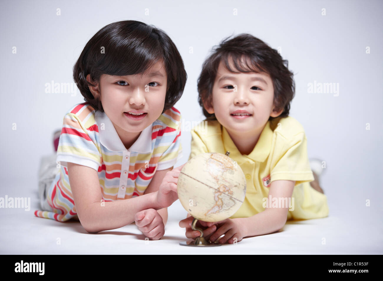 children education touching globe Stock Photo - Alamy