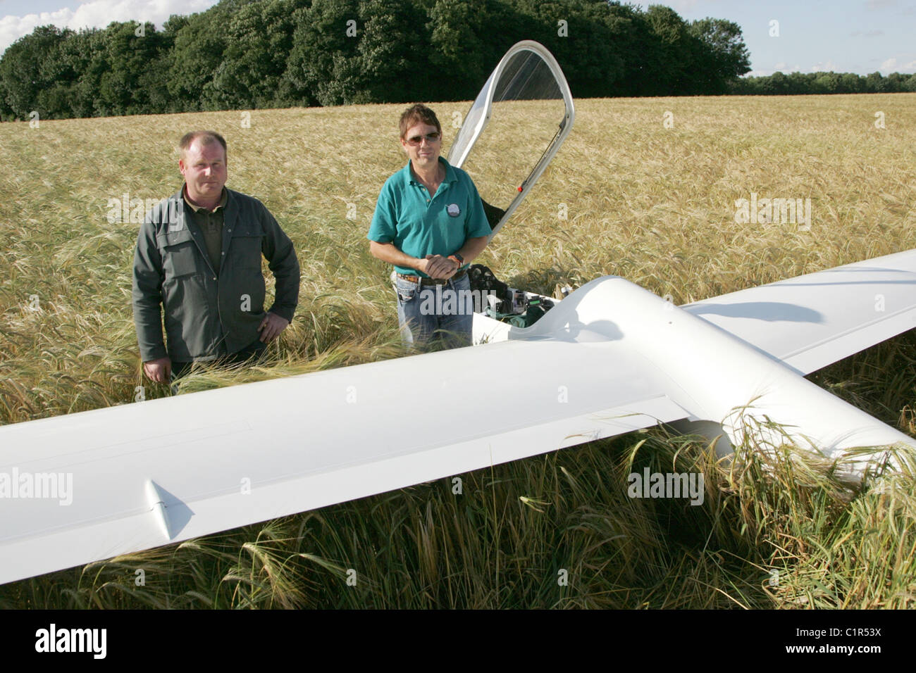 Glider pilot Tim Macfadyen and farmer John Carter stand by a fallen ...