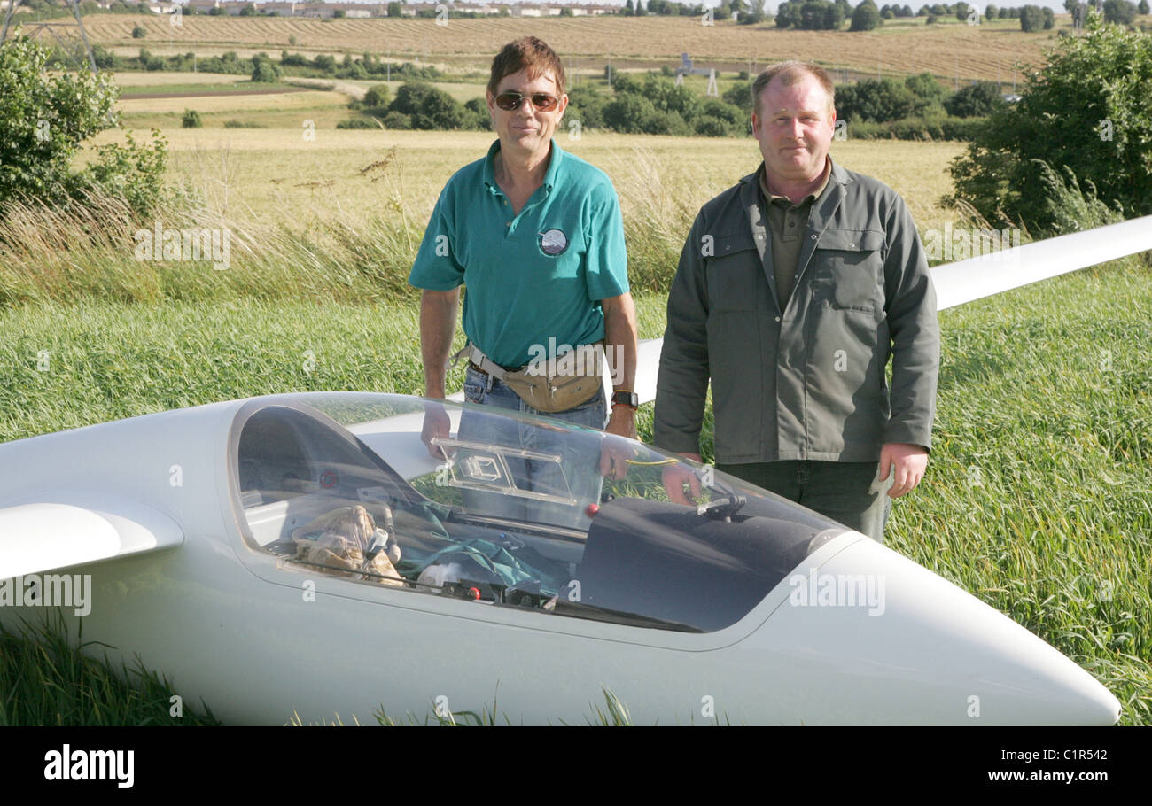 Glider pilot Tim Macfadyen and farmer John Carter stand by a fallen ...