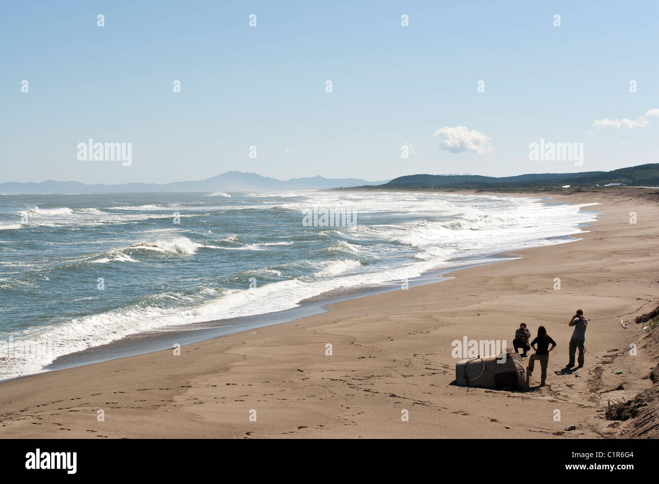 People walk along the beach in Okhotsk, Sakhalin, Russia. September ...
