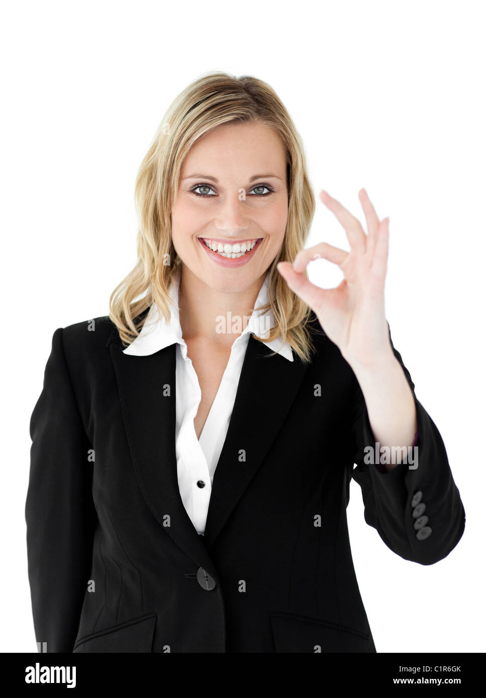 Successful businesswoman showing OK sign against a white background ...