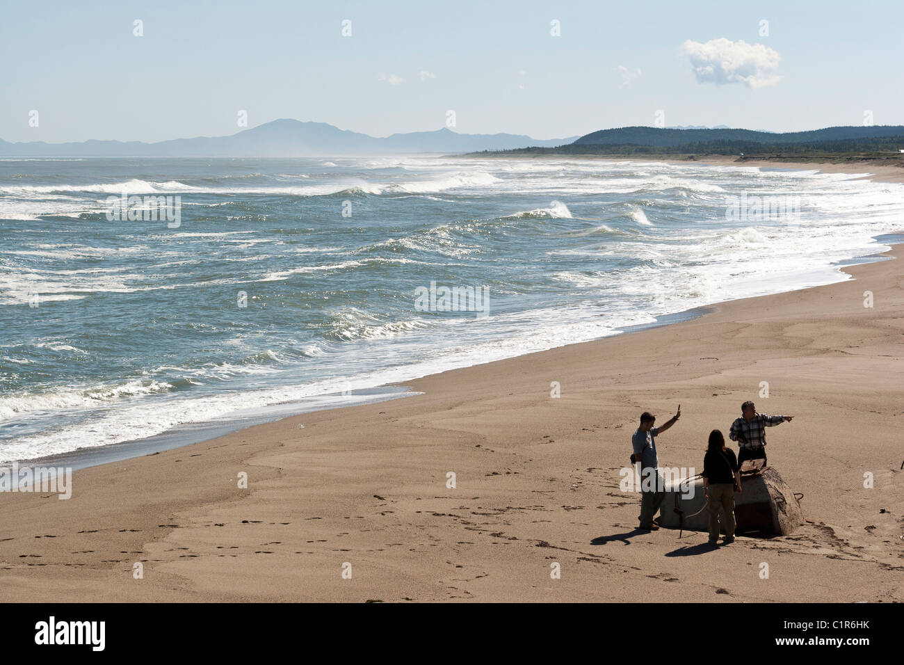 People walk along the beach in Okhotsk, Sakhalin, Russia. September ...
