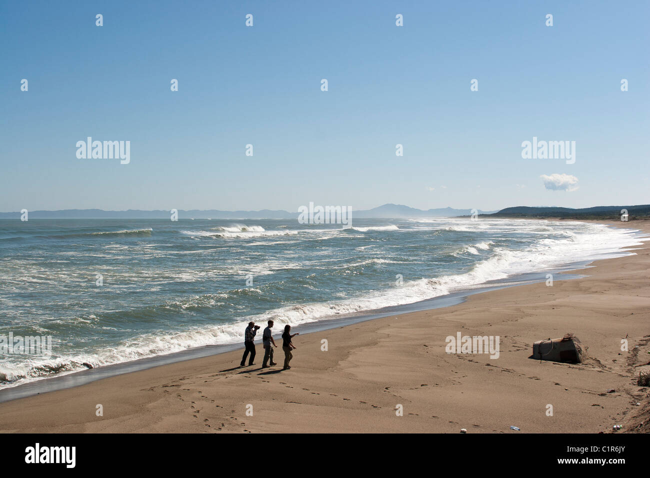 People walk along the beach in Okhotsk, Sakhalin, Russia. September ...