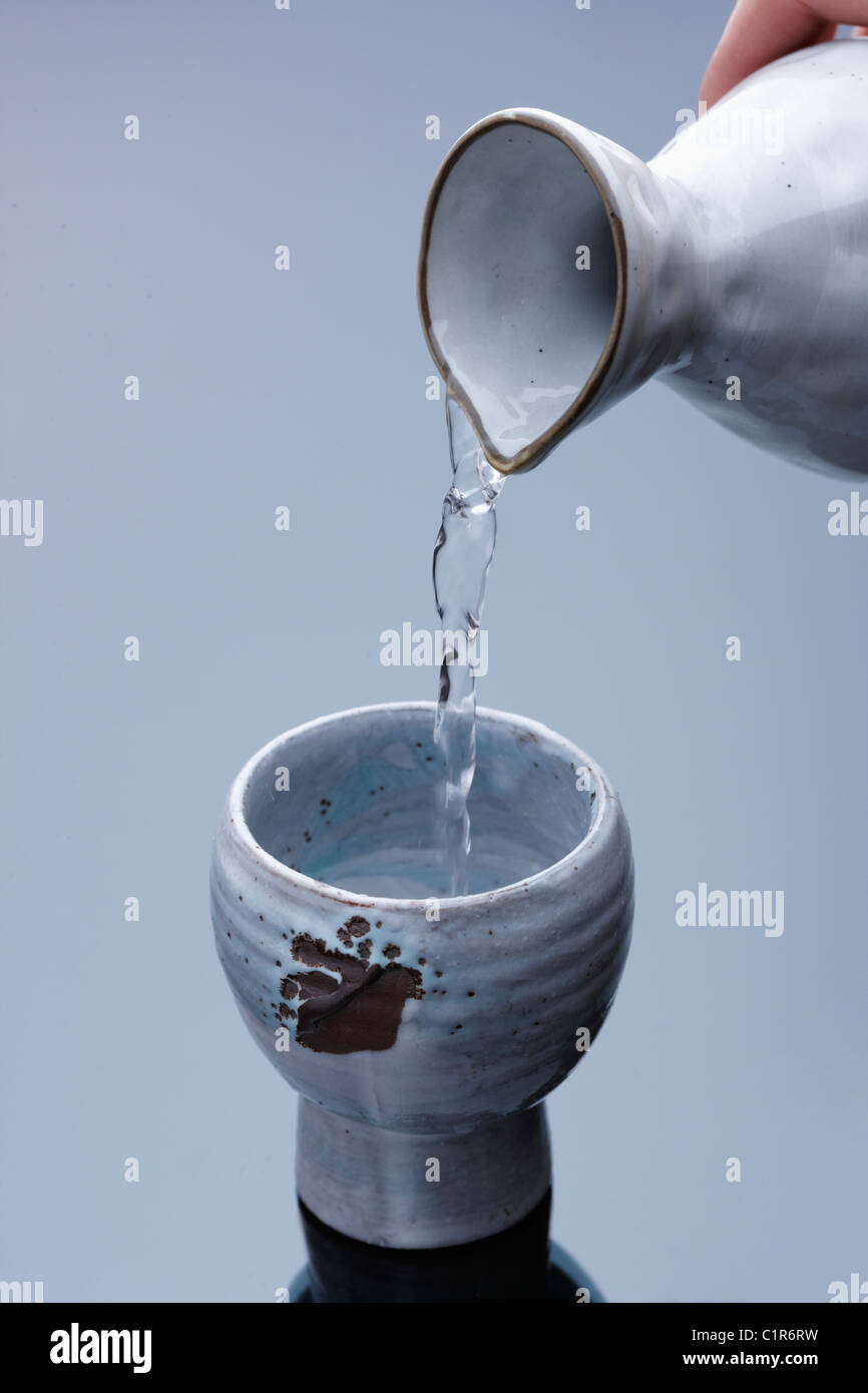 pour sake into glass Stock Photo - Alamy