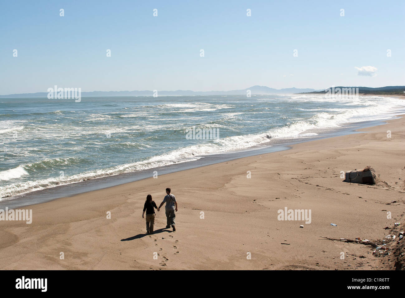 People walk along the beach in Okhotsk, Sakhalin, Russia. September ...