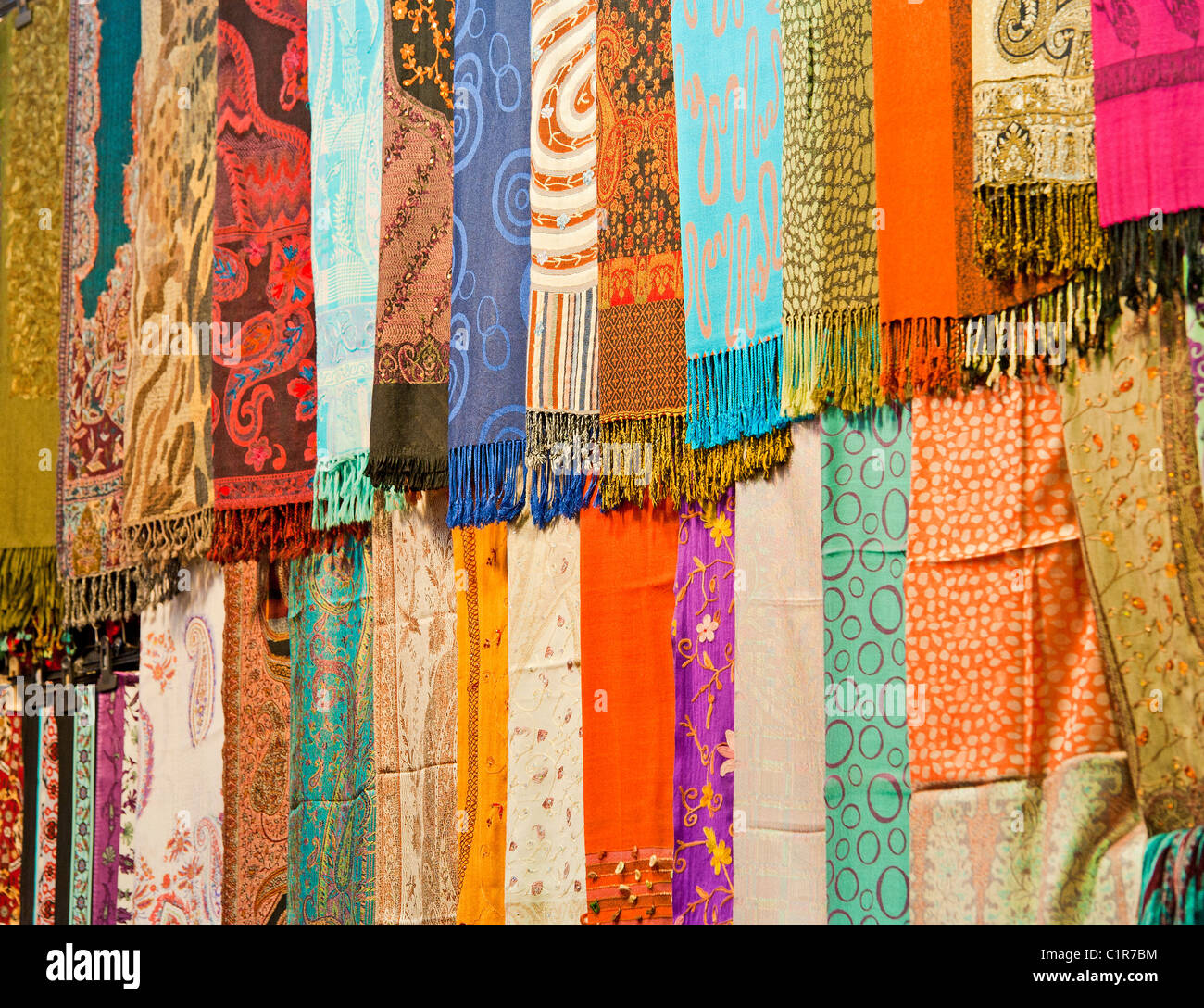 Rows of fabrics hanging at a market stall Stock Photo - Alamy