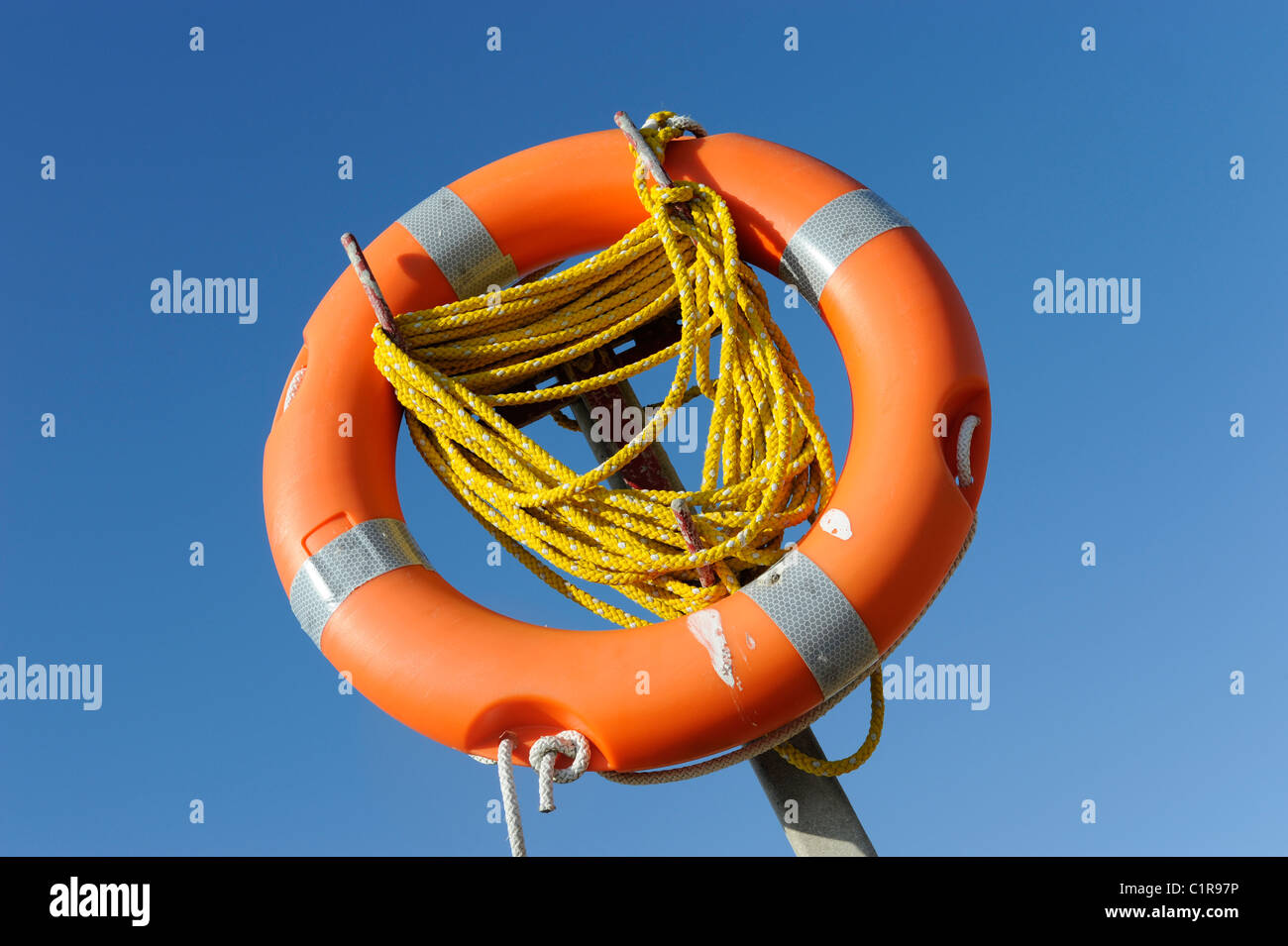 Orange rescue life ring against a blue sky Stock Photo - Alamy