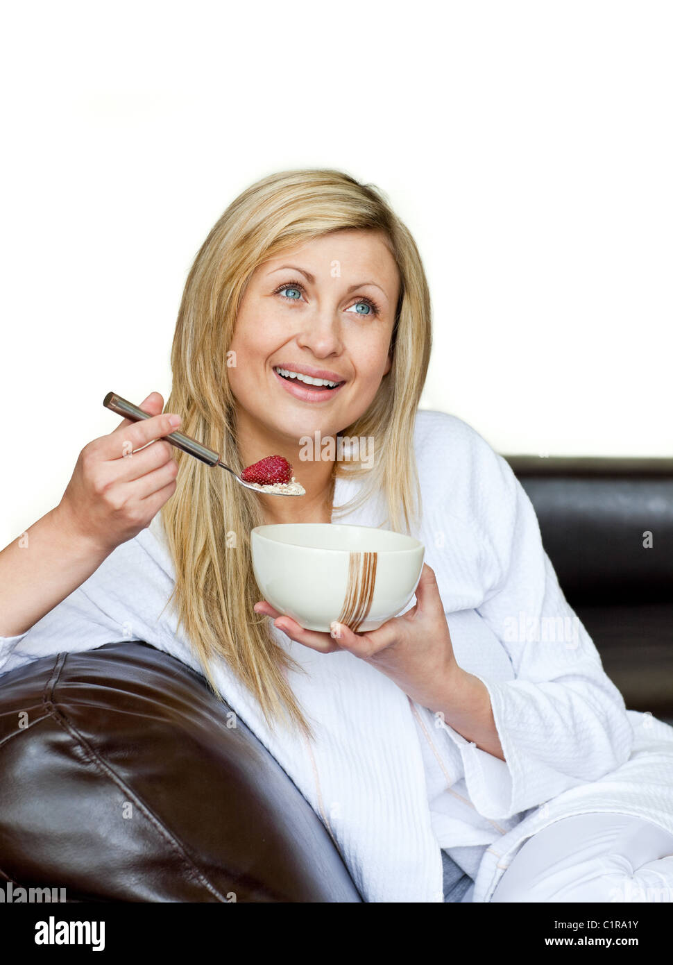Attractive woman having a breakfast against a white background Stock ...