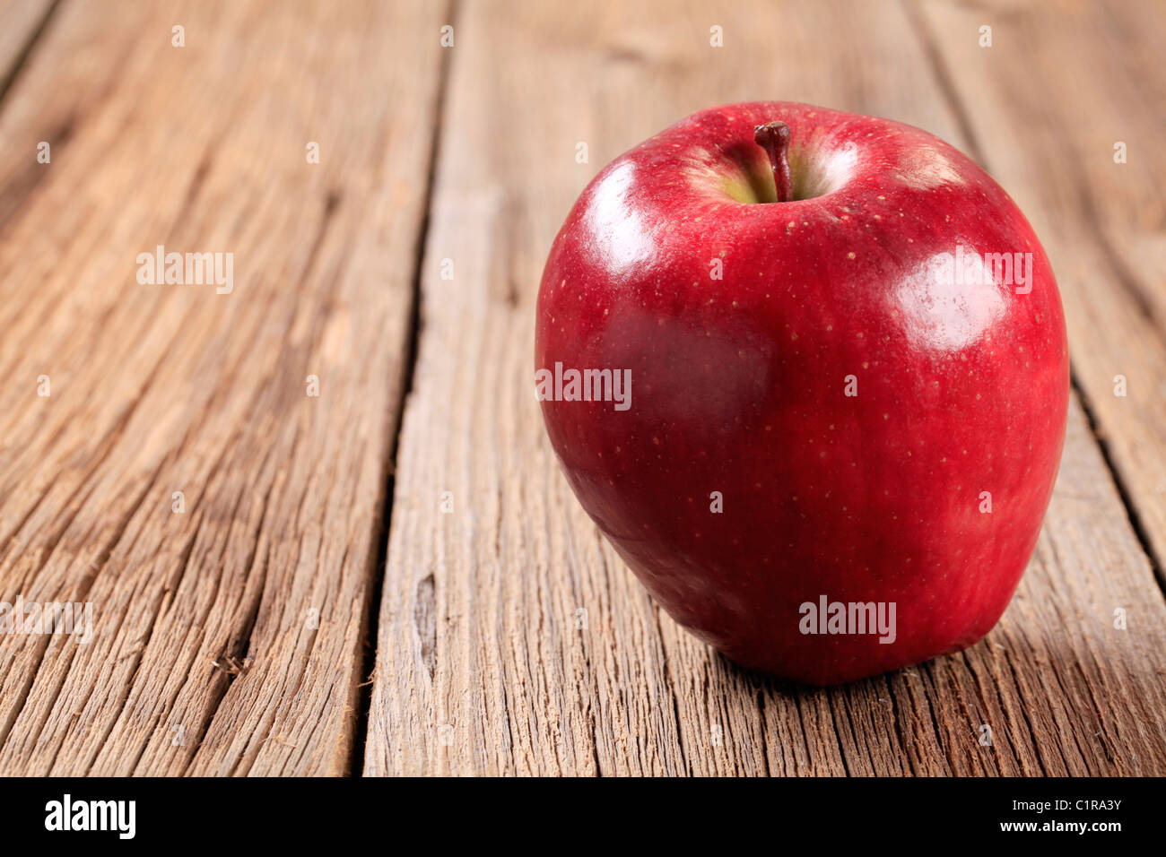 Shiny red apple on wood - closeup Stock Photo - Alamy