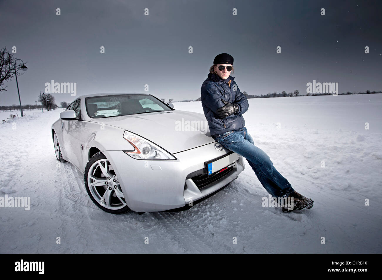 Man Standing in front of his sports car Stock Photo - Alamy