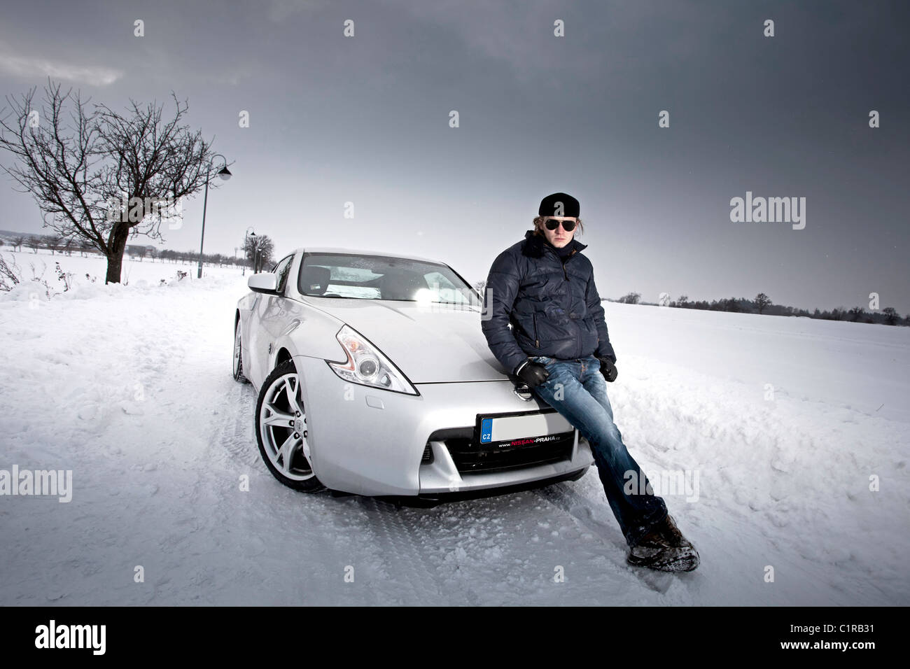 Man Standing in front of his sports car Stock Photo - Alamy