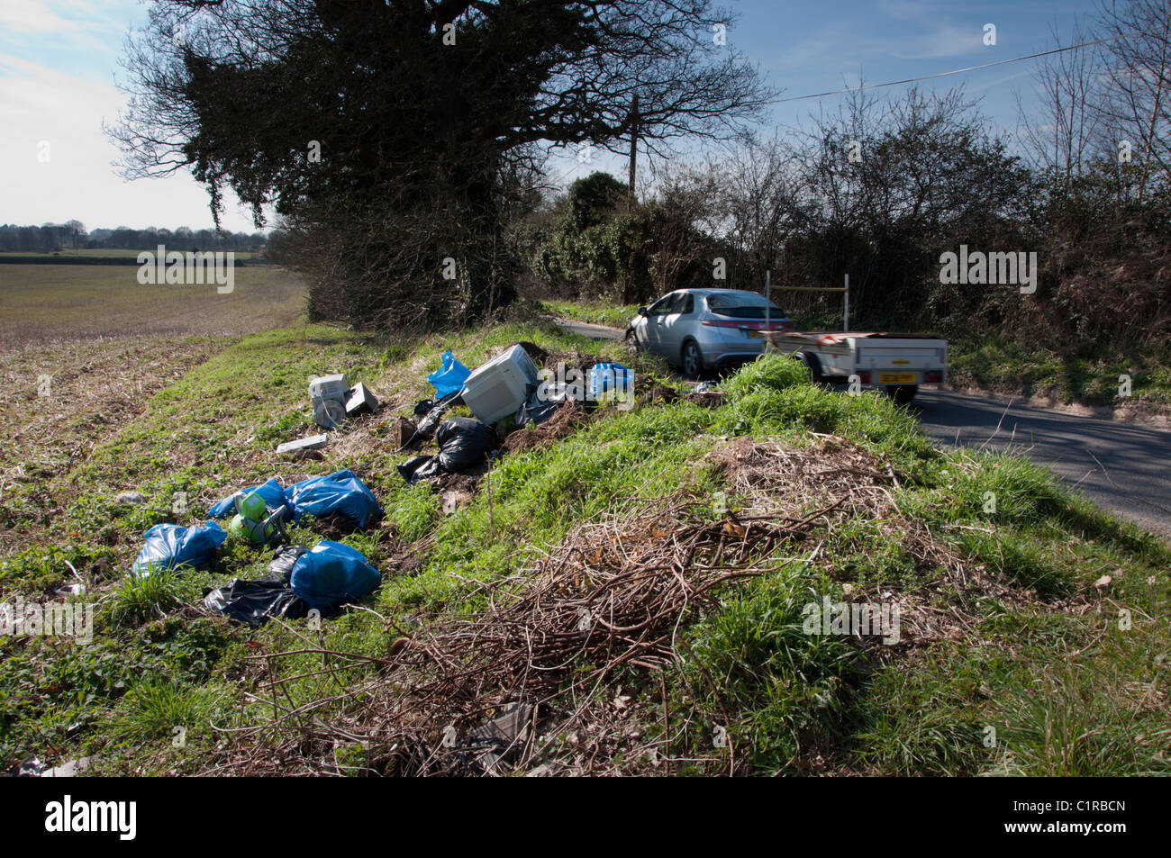 Fly tipping at side of country lane Stock Photo - Alamy