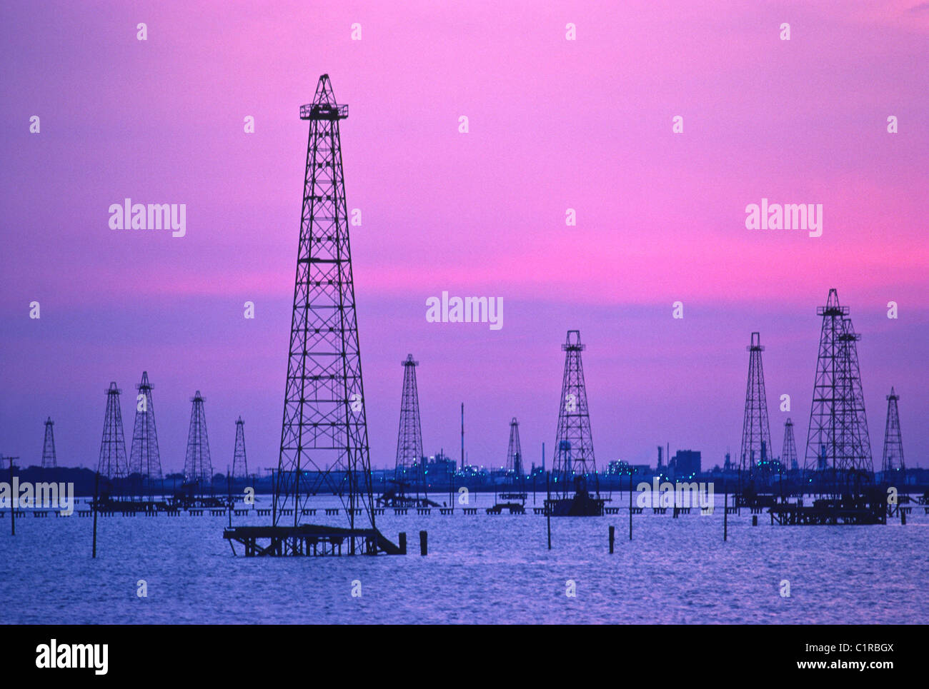 Old oil derricks sit in shallow waters of Goose Creek Oil Field ...