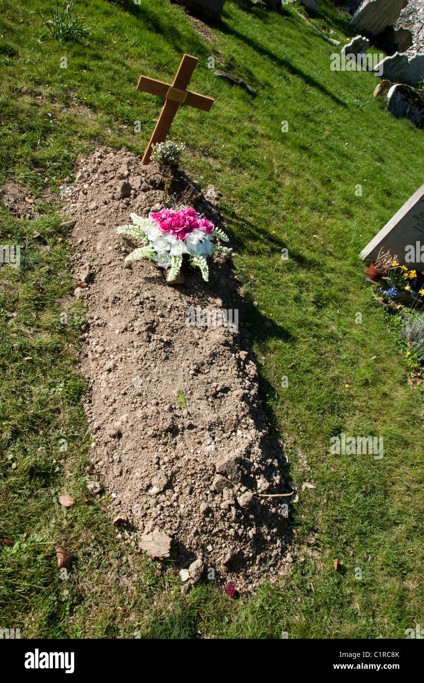 New Grave in old church yard Stock Photo - Alamy