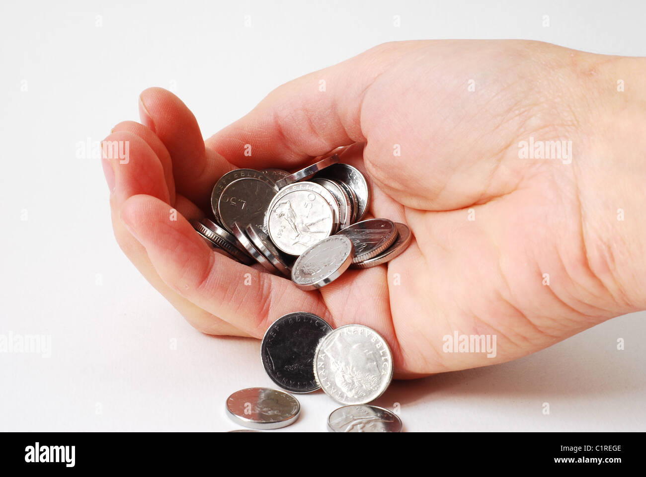 Metal coins in human hand Stock Photo - Alamy