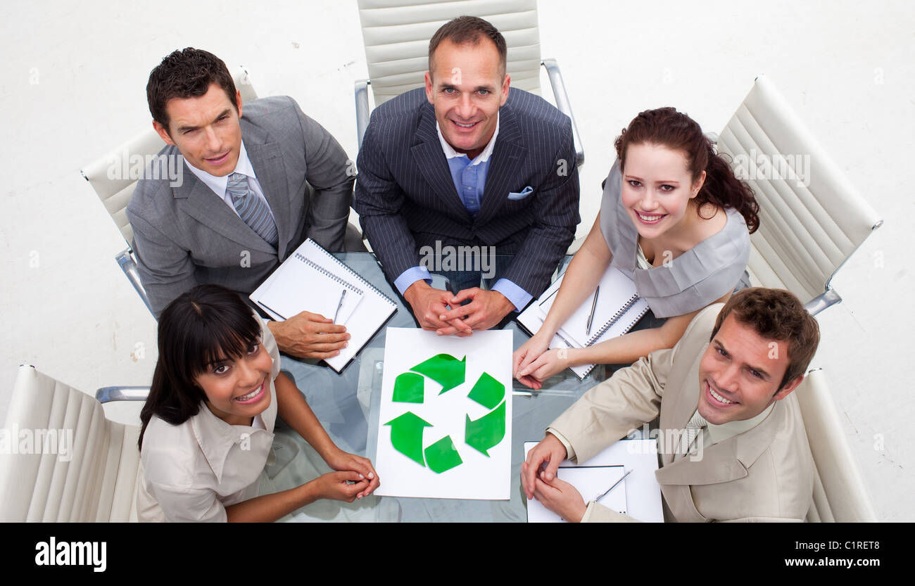 High angle of smiling business team holding a recycling symbol Stock ...